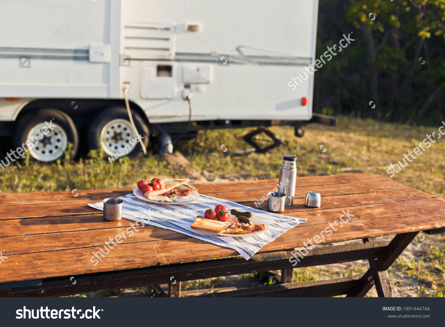 Breakfast near the travel trailer. Breakfast in nature. Fried eggs with ...