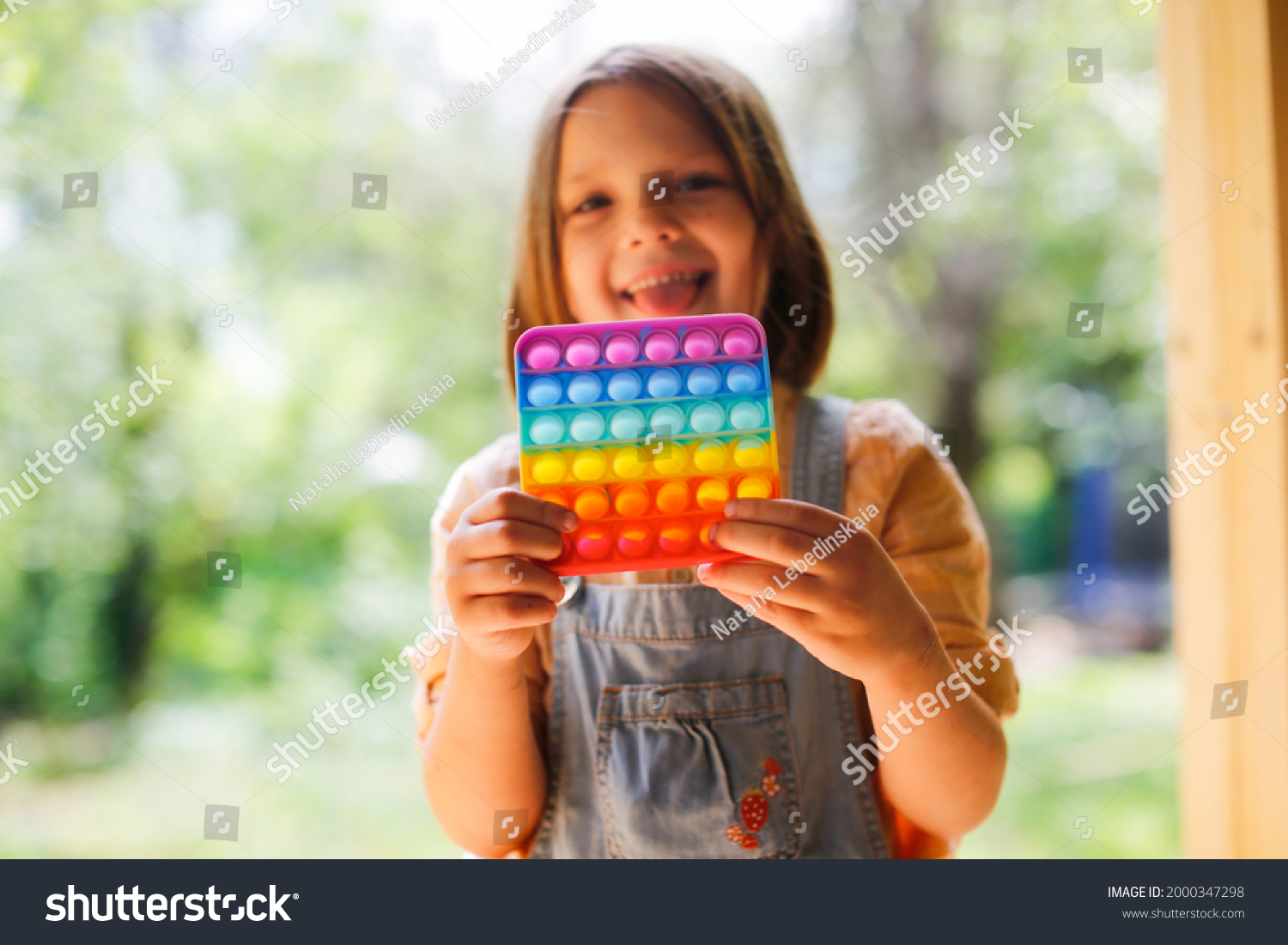 Happy European Child with Colorful Rainbow Pop It Pop Fidget Sensory ...