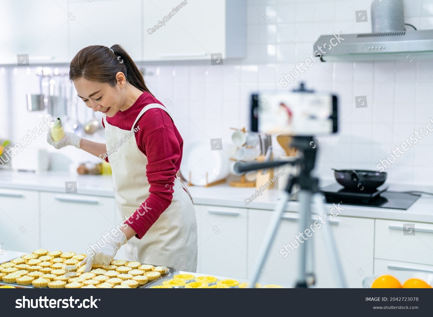 Asian woman bakery shop owner using smartphone with internet ...