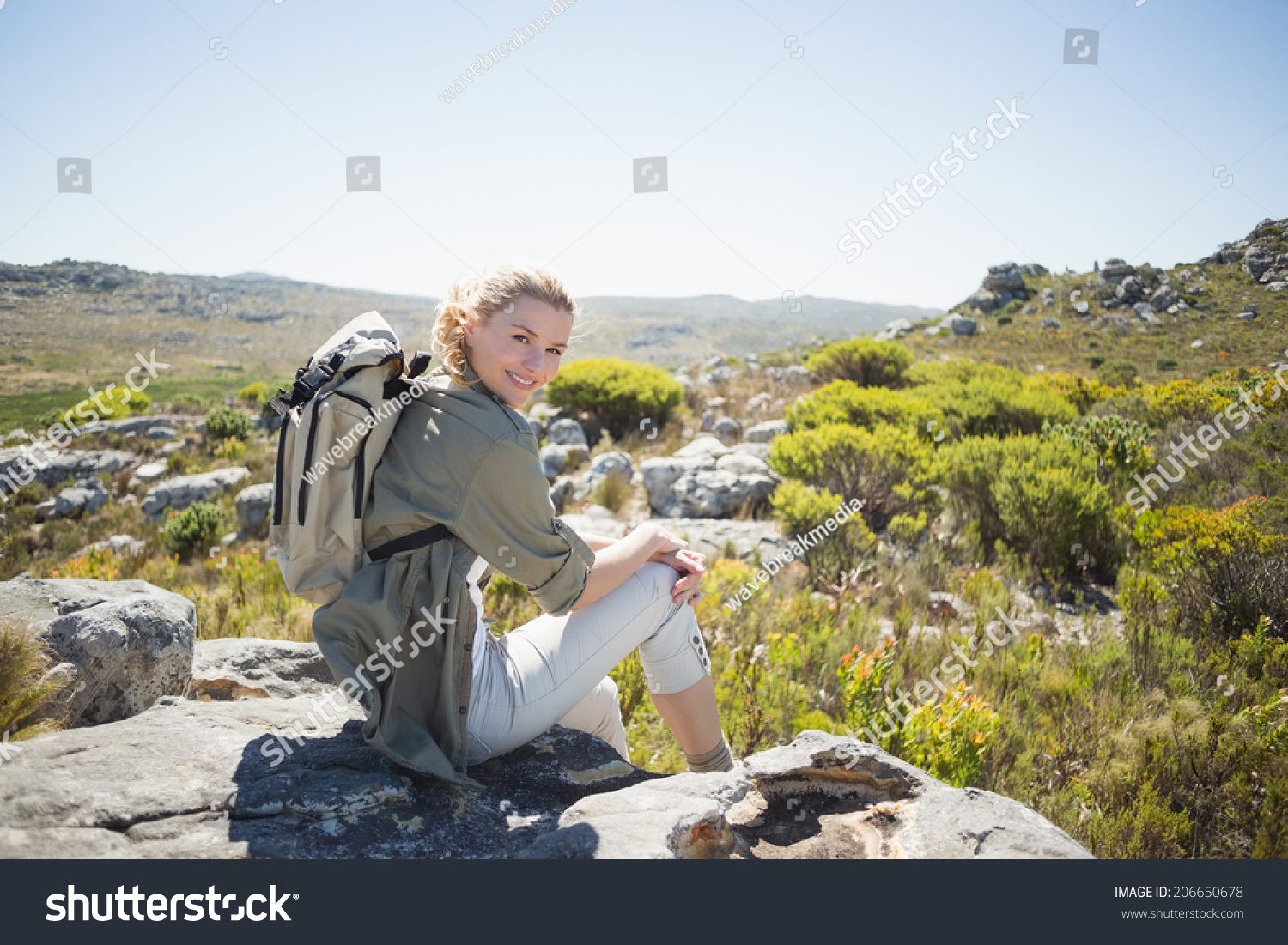 Pretty hiker sitting at the summit smiling at camera on a sunny day_站酷海 ...