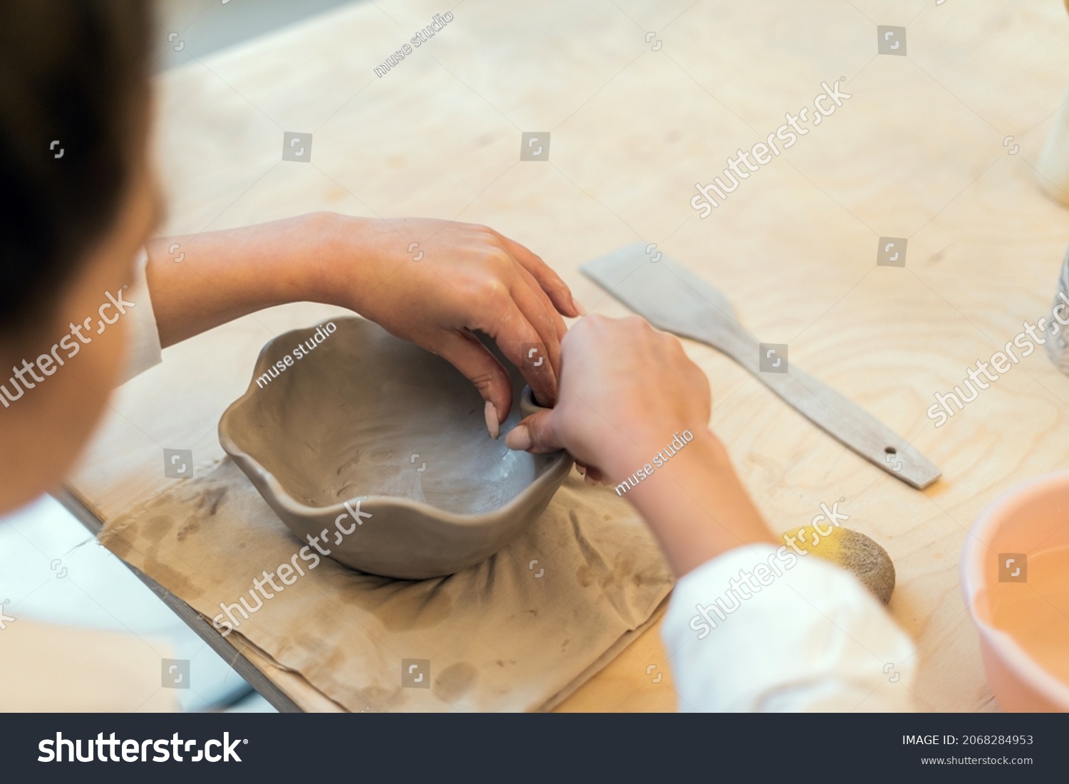 The sculptor makes handmade tableware. The master of ceramics is a ...
