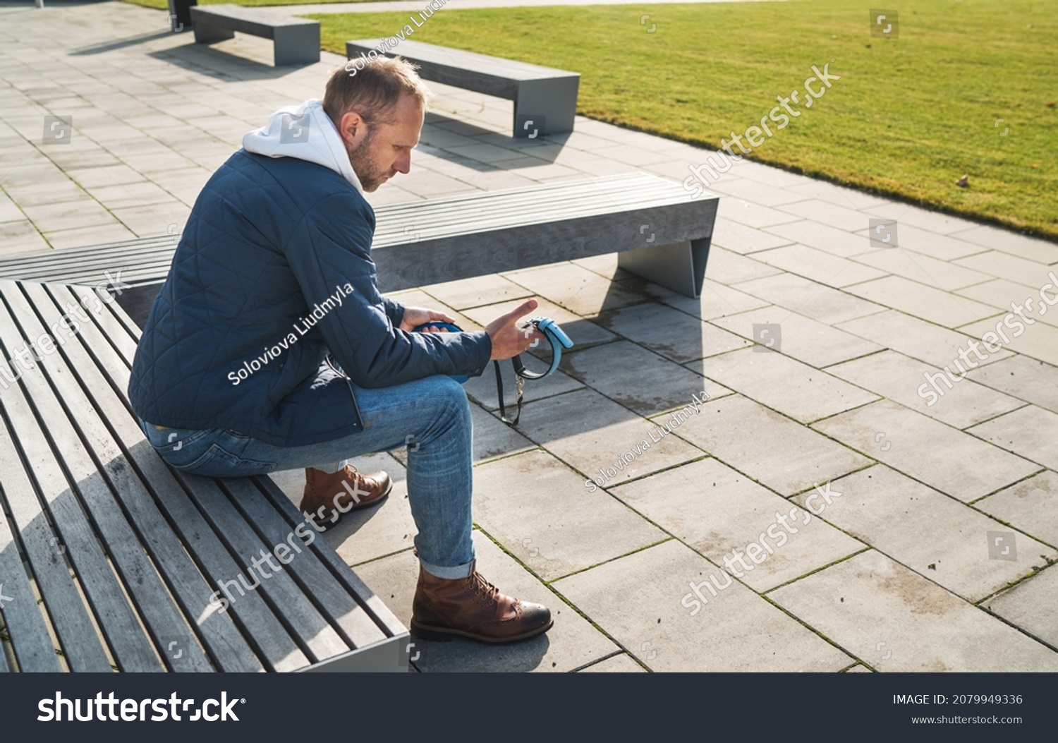 Broken with grief man grieving dog owner holding the lovely pet collar ...