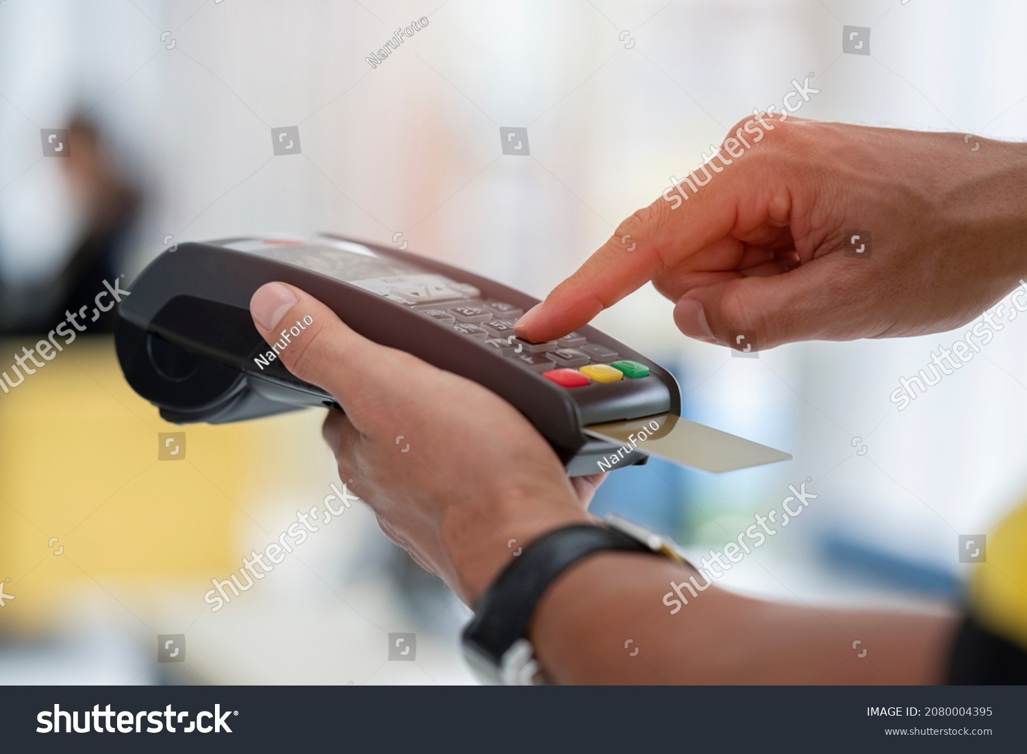 Cashier holding credit card reader machine on hand with insert card for ...