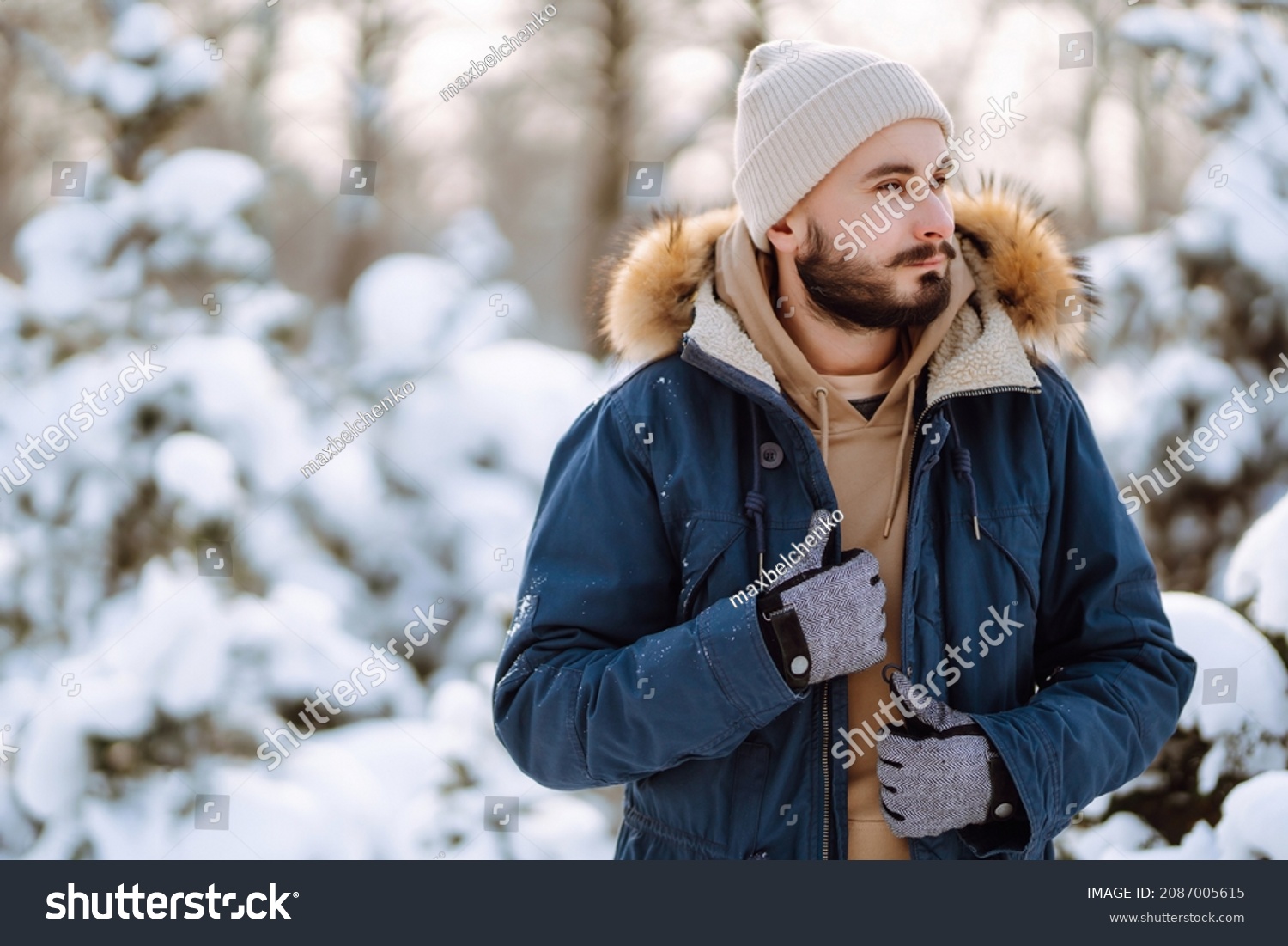 Portrait of young man in snowy winter forest. Season christmas travel ...