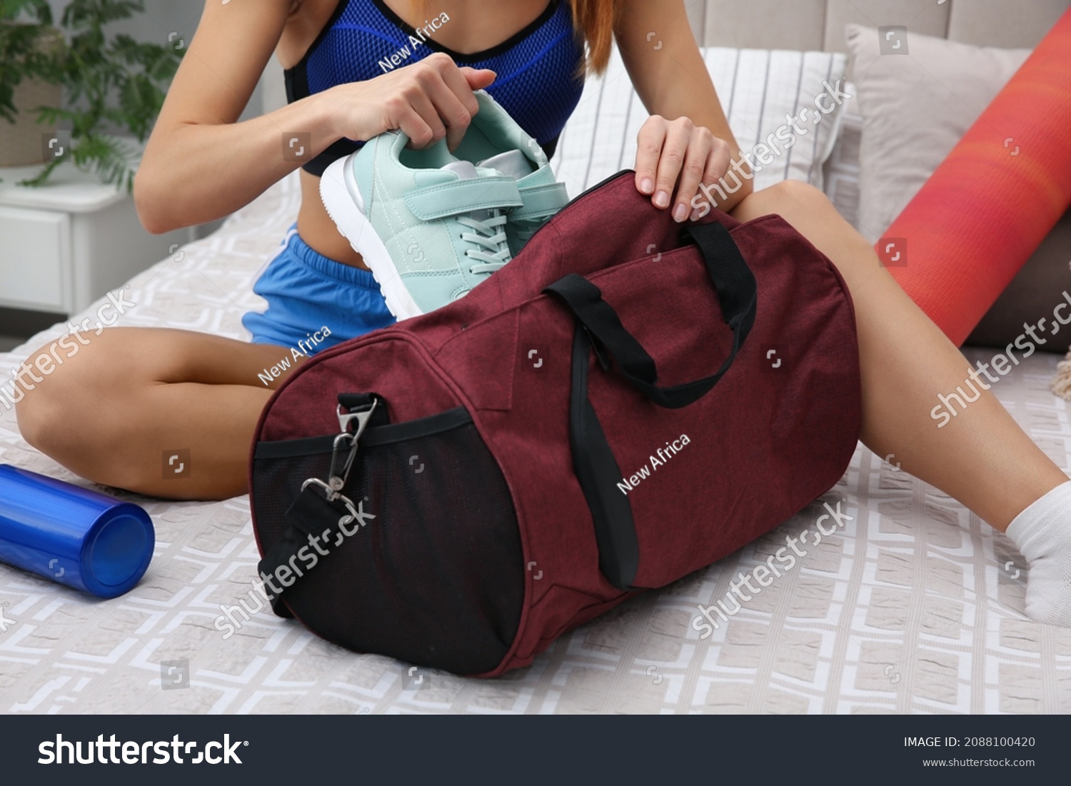 Woman packing sports stuff for training into bag at home closeup_站酷海洛 ...
