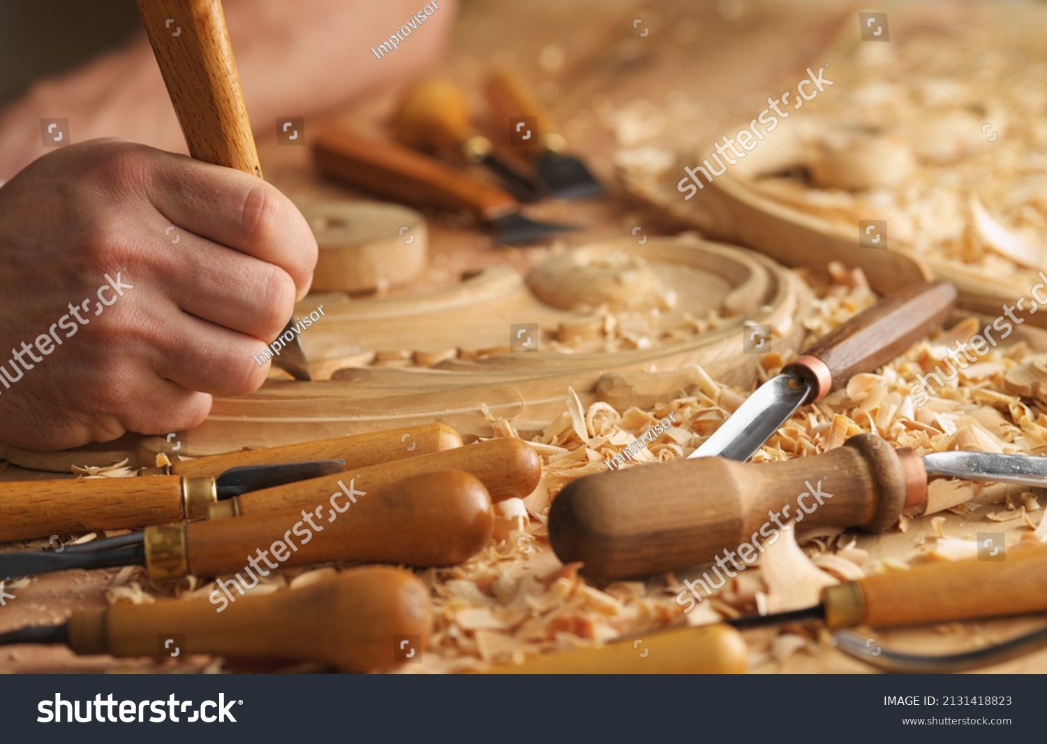 Craftsman carving with a gouge. Woodwork. Workbench with equipment ...