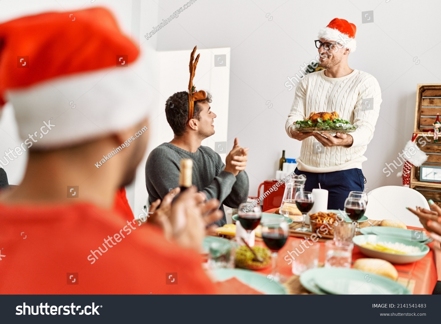 Group of people meeting clapping and sitting on the table. Man standing ...