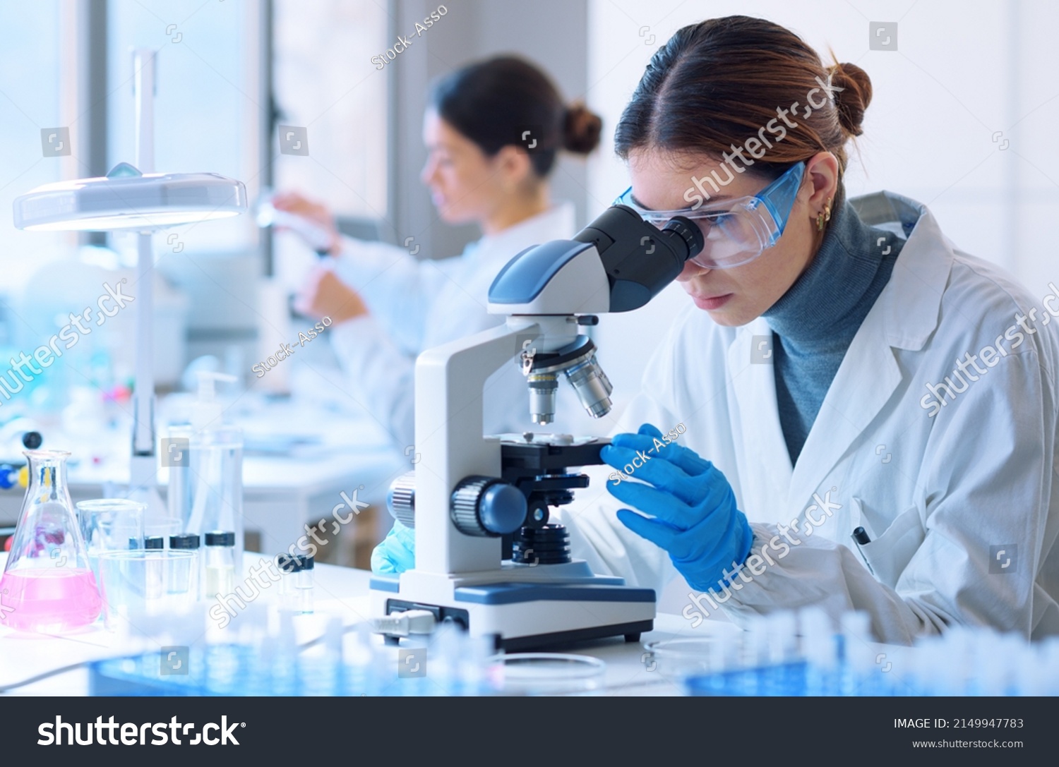 Young scientists conducting research investigations in a medical laboratory a researcher in the ...