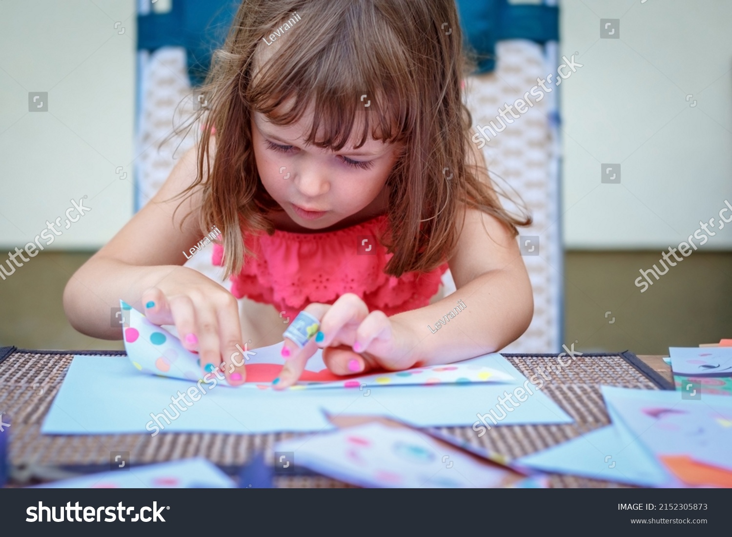 Cute little girl playing on paper art origami. Children being creative ...