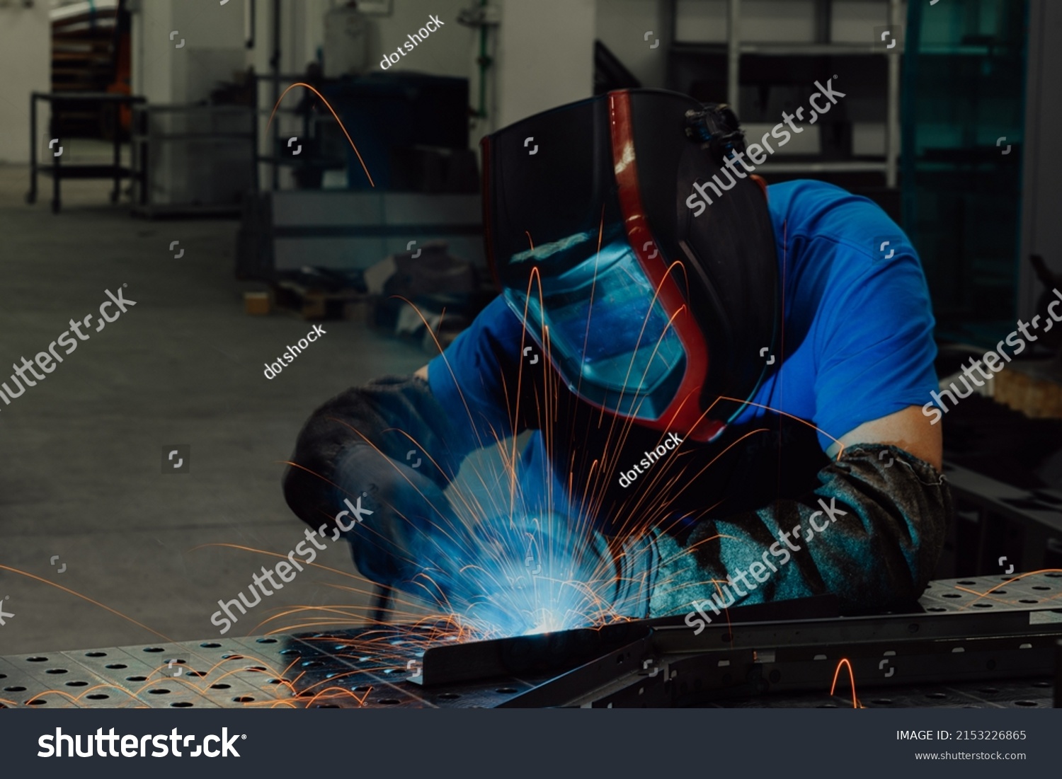 Professional Heavy Industry Welder Working Inside factory Wears Helmet ...