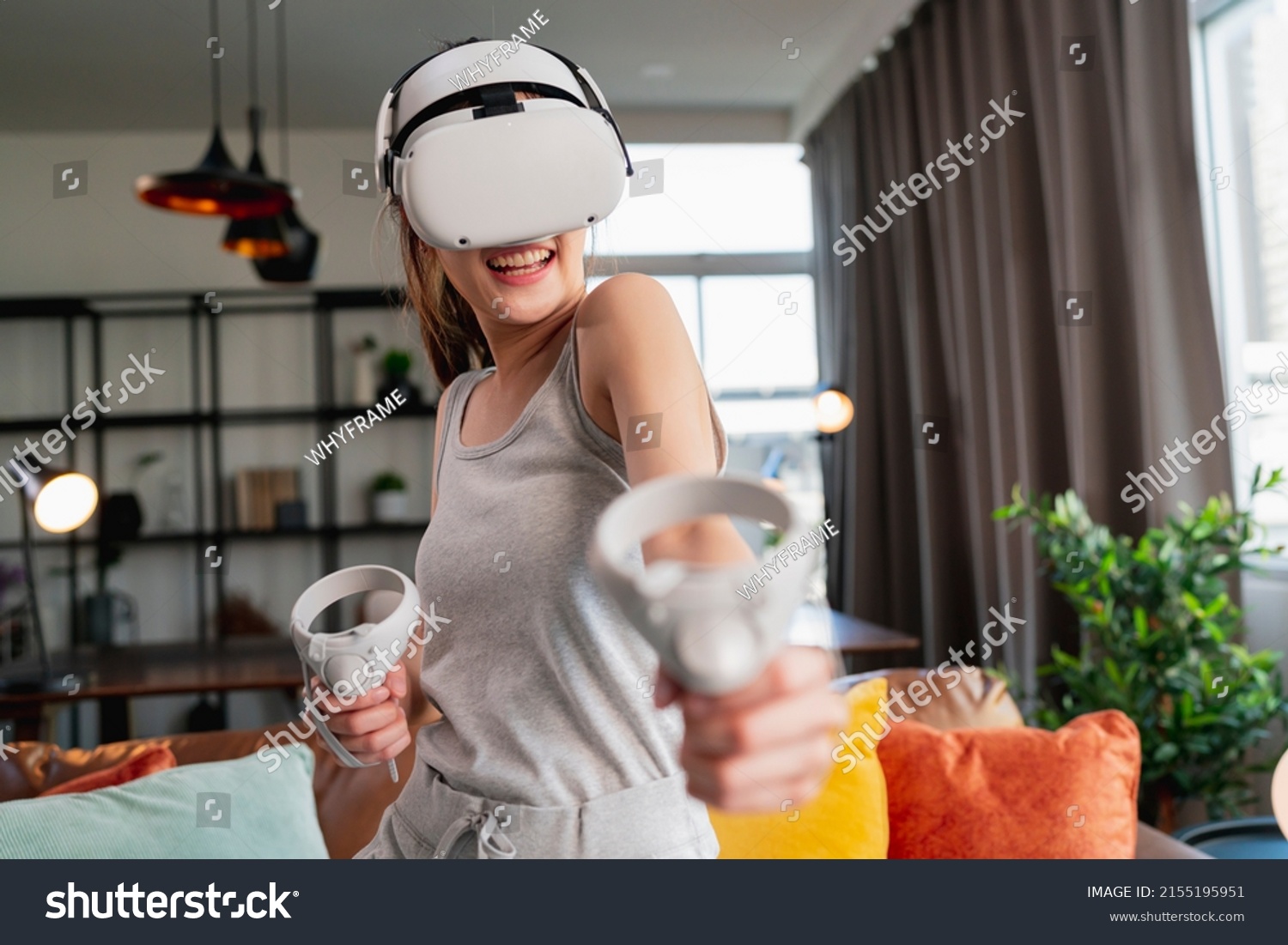 exitied enjoy 3d virtual gaming futuristic experience young asian female wear vr headset ...