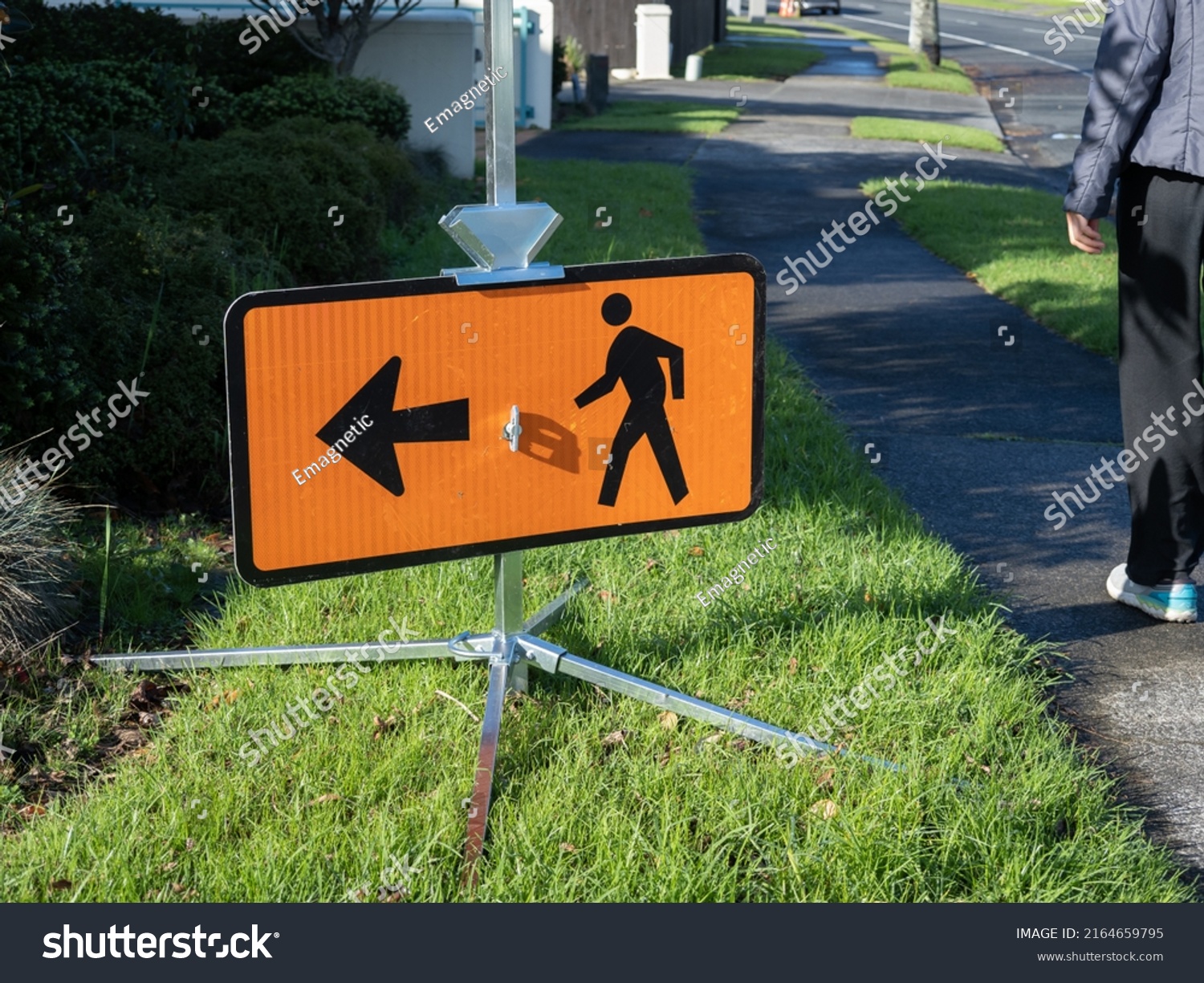 Pedestrians follow this sign with left arrow. New Zealand temporary ...