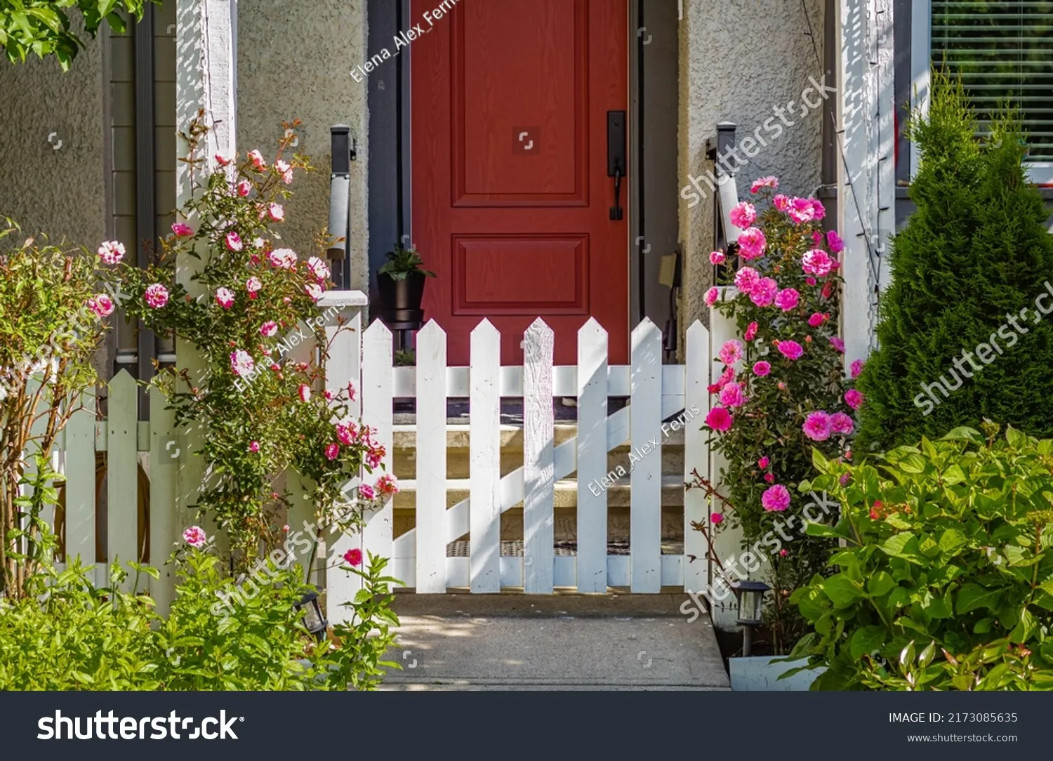 Entrance to a home through a beautiful garden with colorful flowers ...