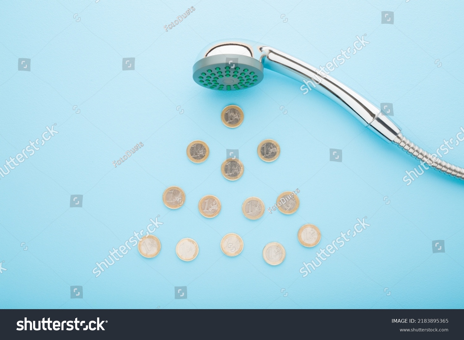 Euro coins as drops falling from shower head on light blue table ...