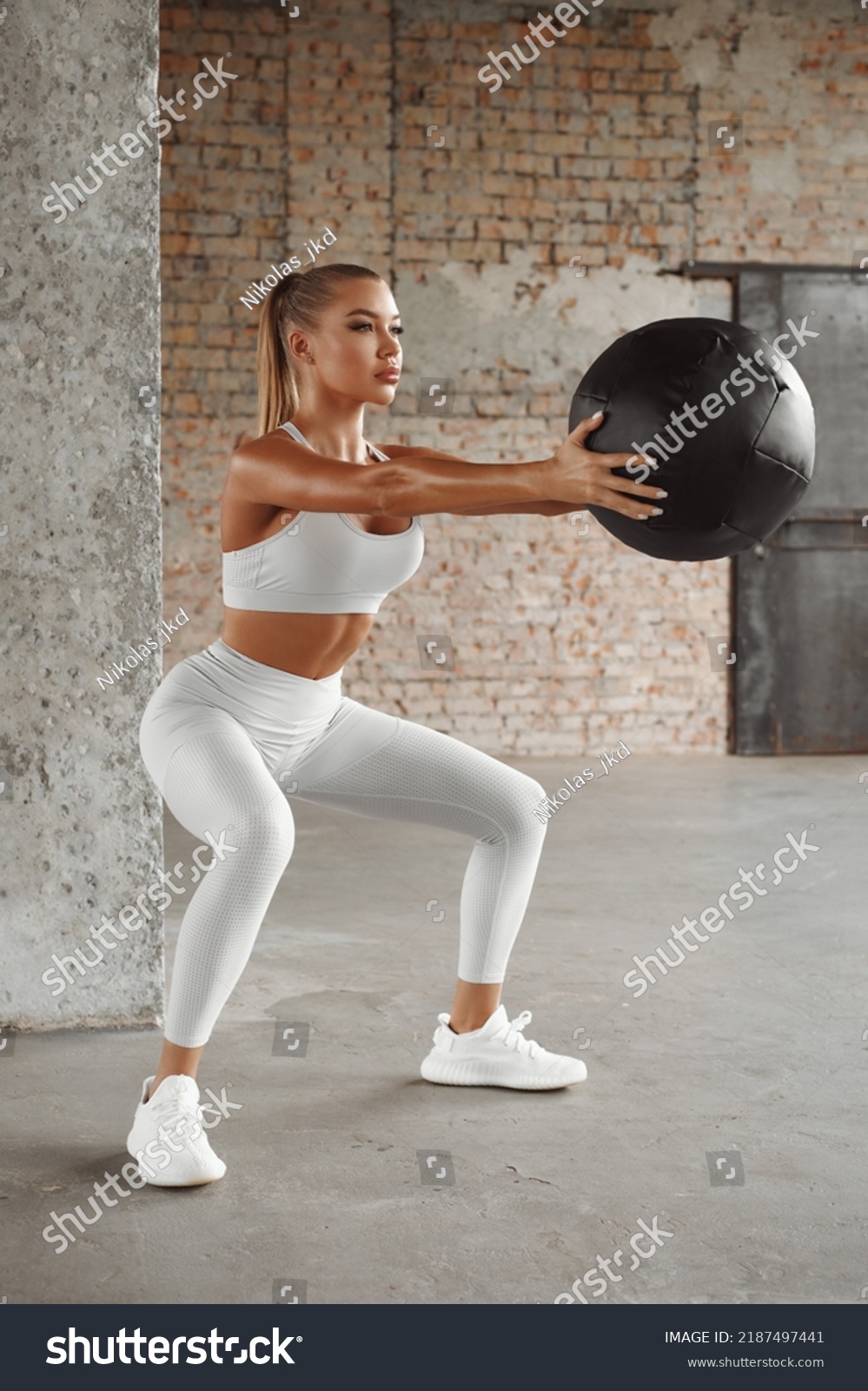 Fitness woman doing squat exercise for glute in gym. Athletic girl ...