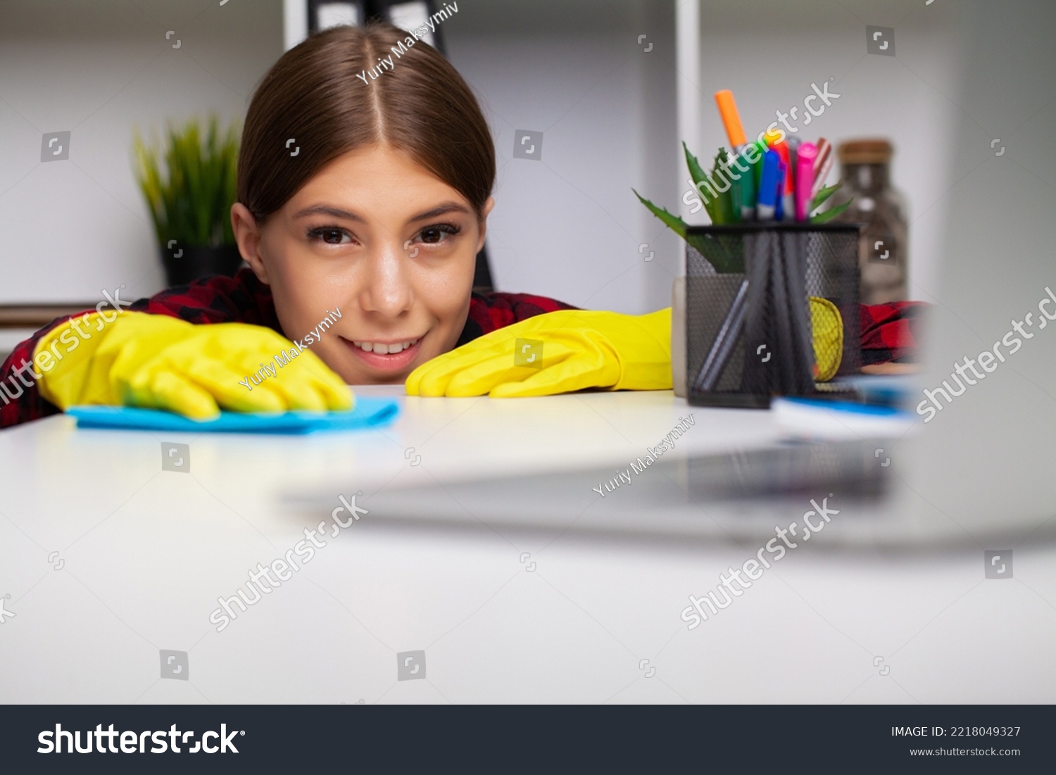 Cleaner cleans office in the yellow gloves wipes the dust off the ...
