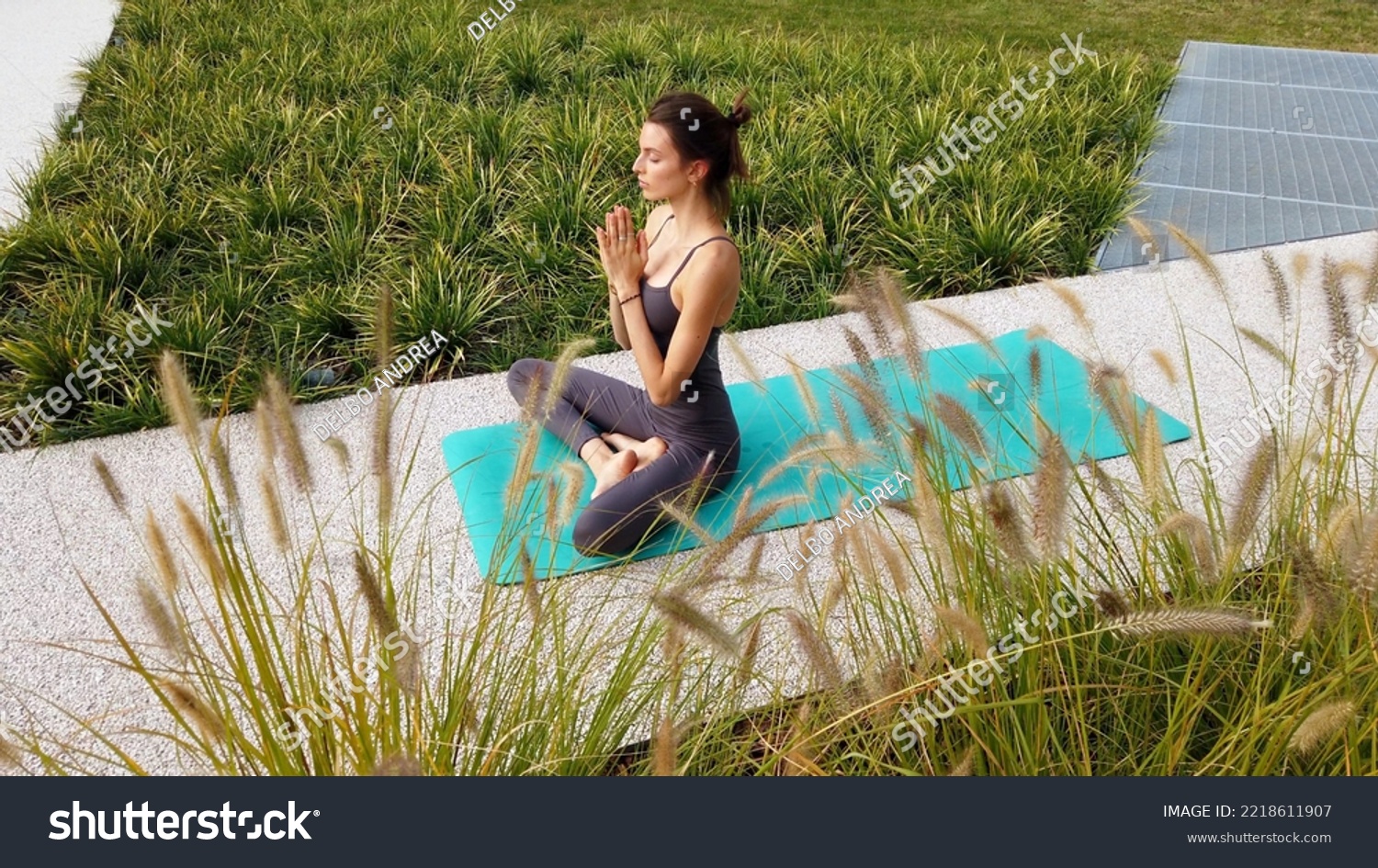 Young girl performs yoga gymnastic sport in natural botanic garden in ...