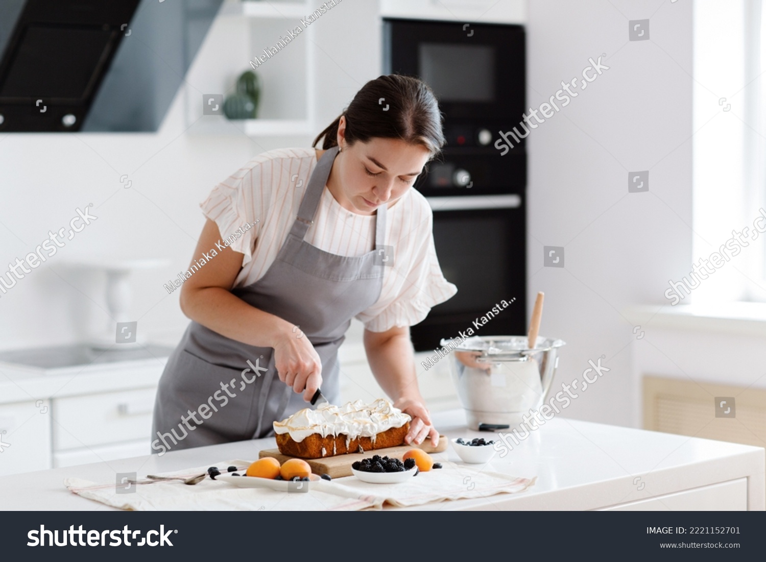 The confectioner prepares a delicious dessert in the kitchen. cooking ...