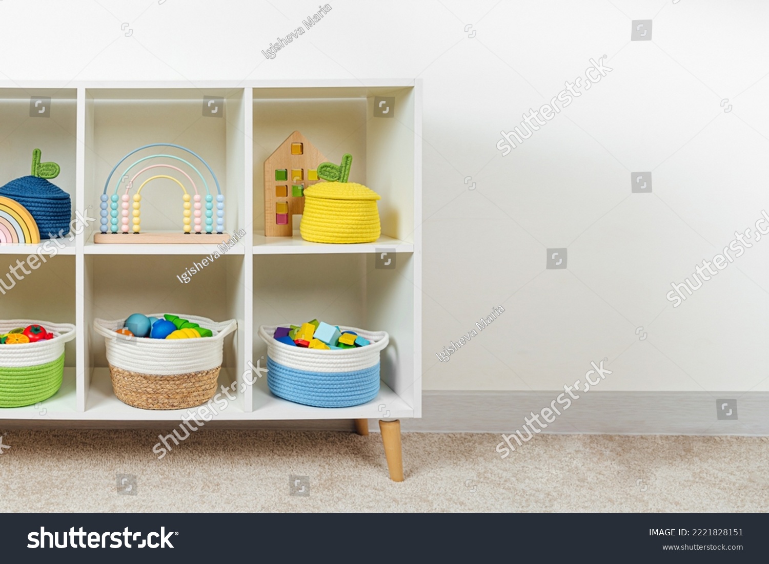 Colorful storage baskets on shelves. White shelving with rainbow wooden ...