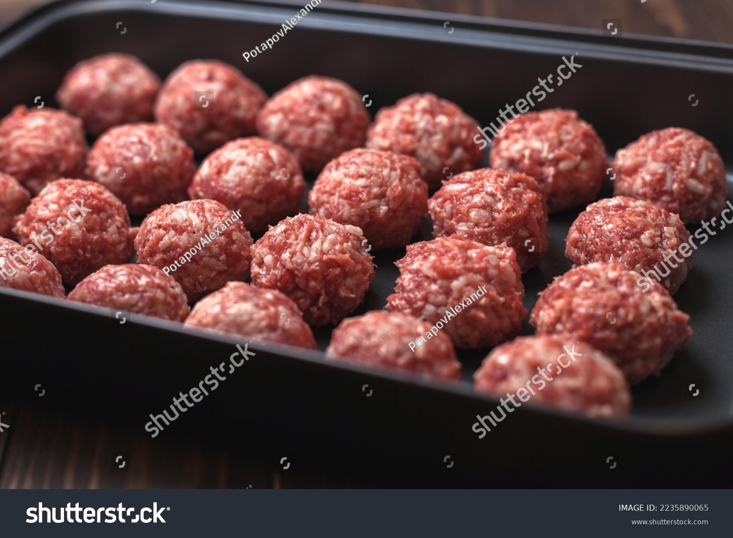 Raw meatballs on Baking trays are prepared and ready for baking in the ...