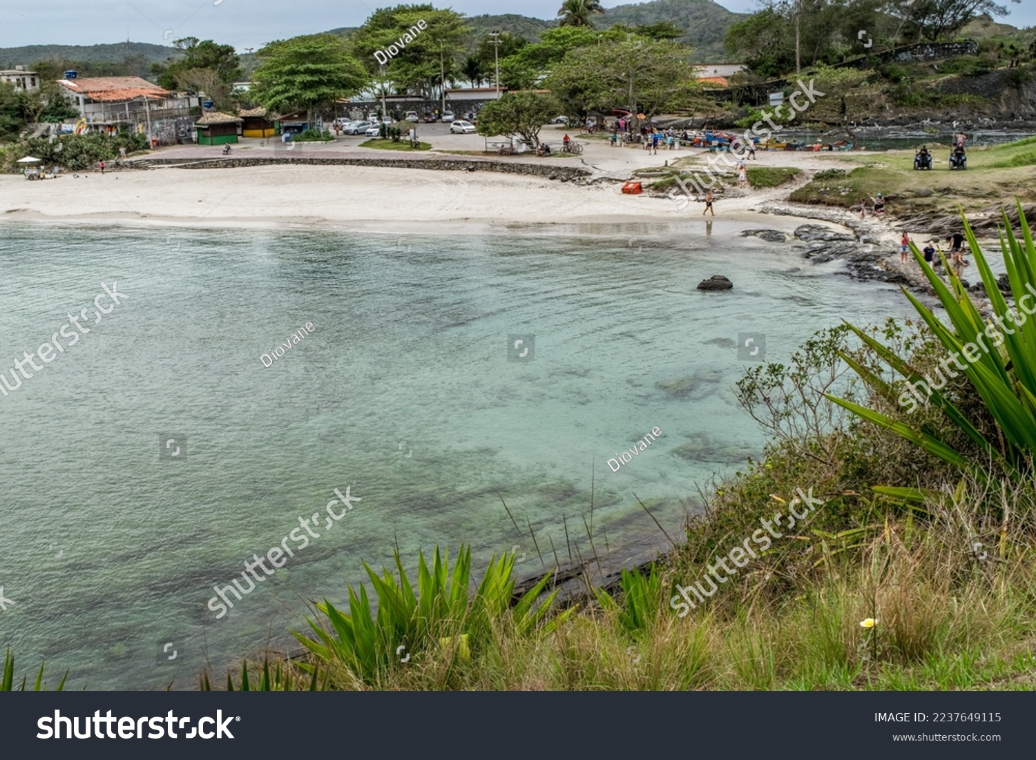 Beaches around Forte São Mateus in Cabo Frio many people walking on the ...
