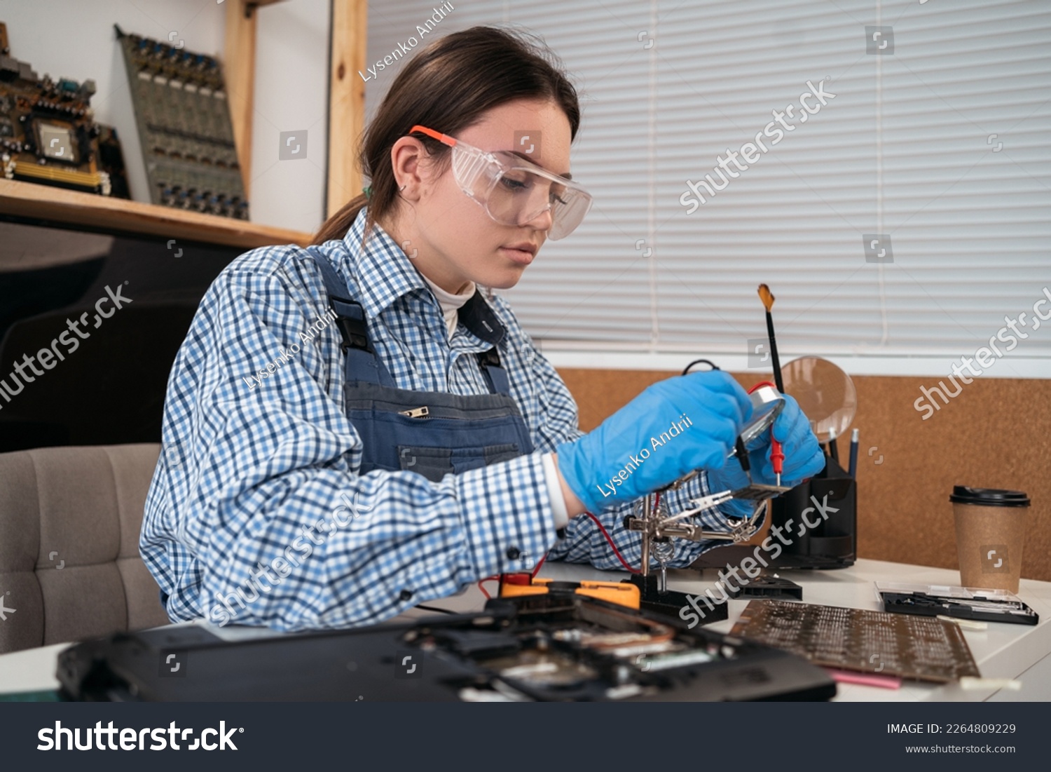 Computer service and repair concept. Woman repairing the broken laptop computer in service ...