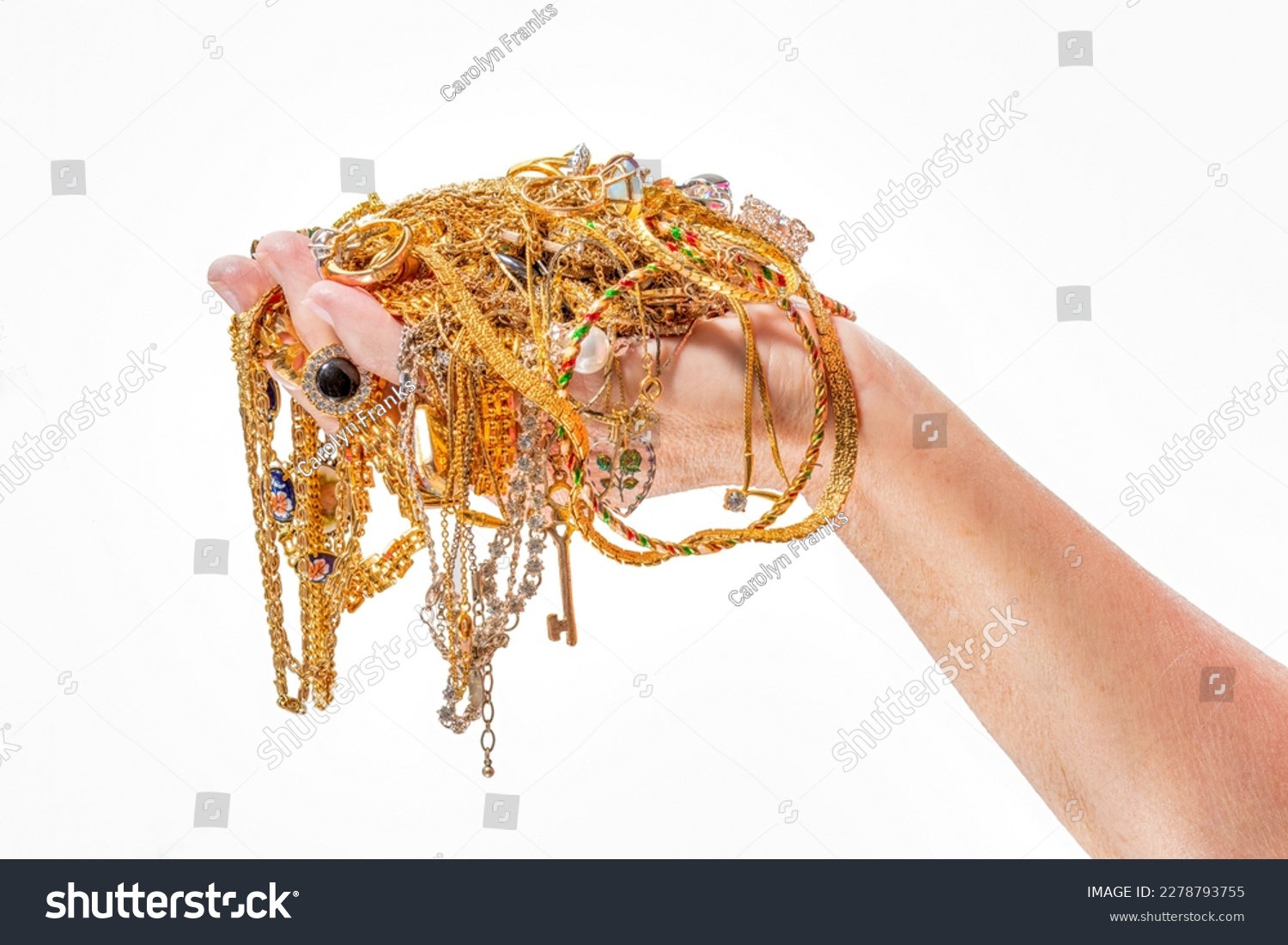 Horizontal shot of a woman’s hand holding gold jewelry isolated on ...