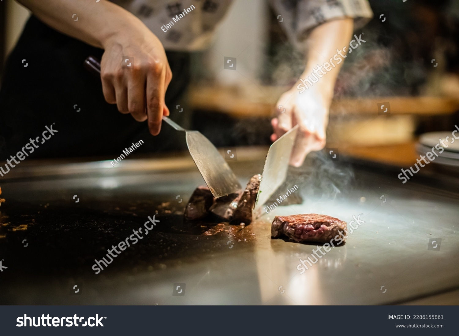 Tepanyaki - japanese grilled beef on pan. chef cooking at the hot table ...