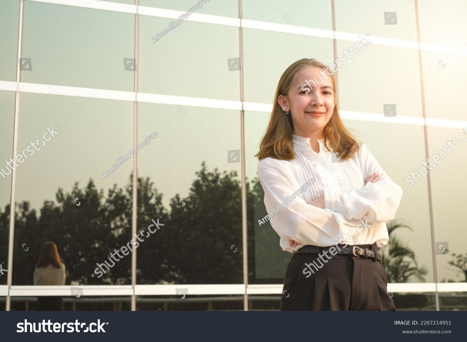 Professional business women standing crossed arms outside building city in the morning. She was ...
