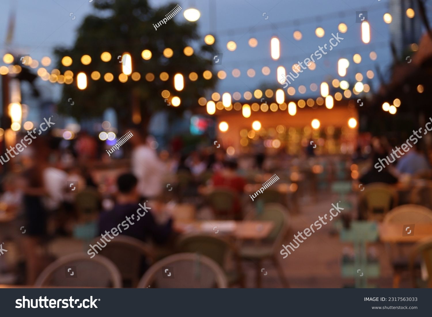 blurred image at the restaurant night time many people in the ...