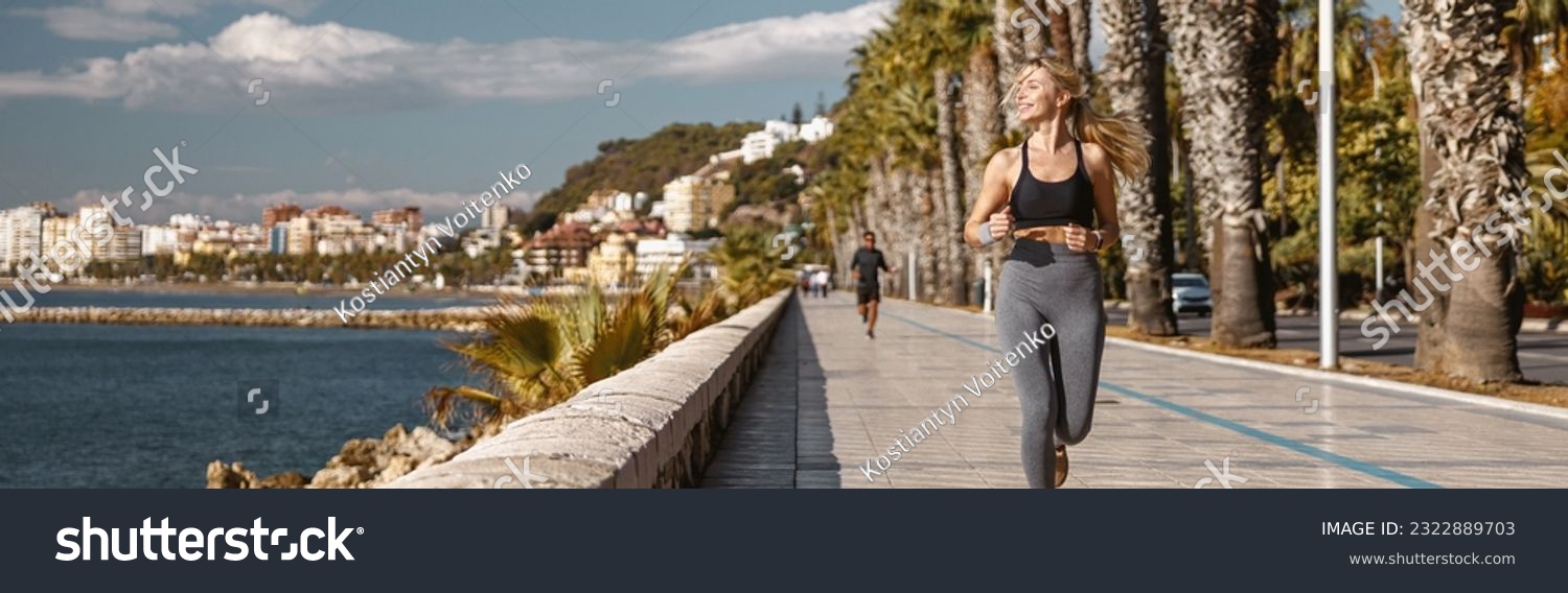 Sporty female jogging on sidewalk along seashore_站酷海洛_正版图片_视频_字体_音乐素材交易 ...