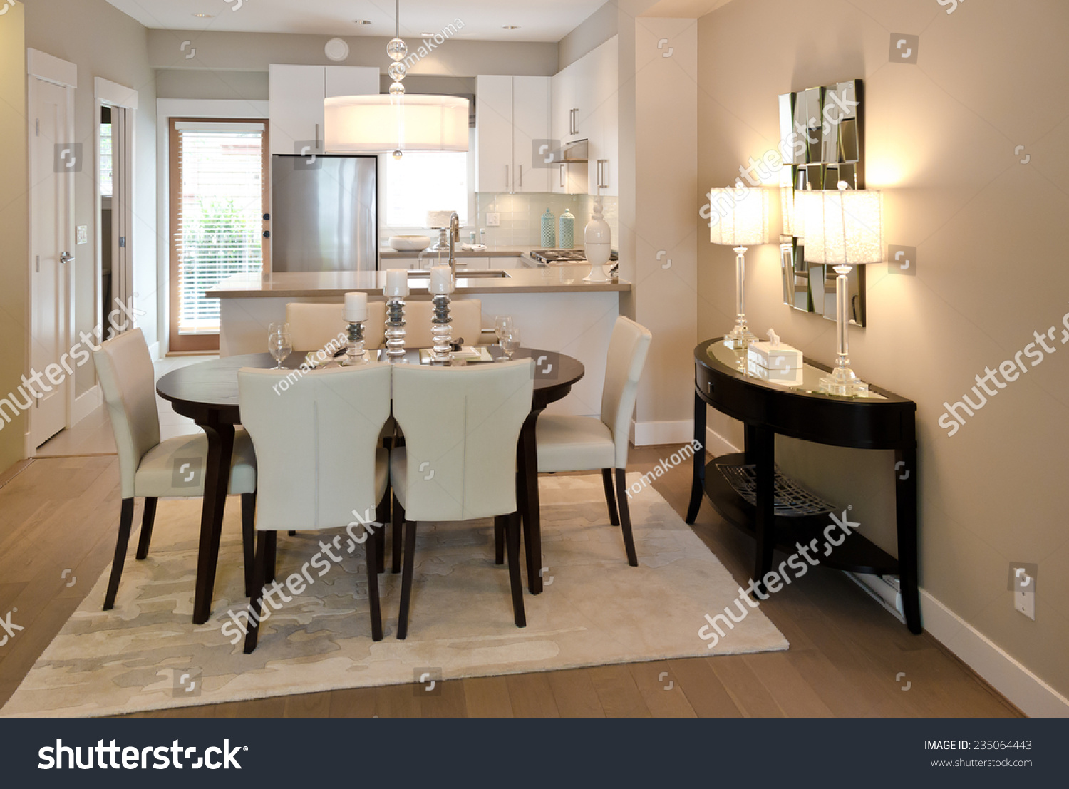 Nicely decorated and served living lunch room table with the kitchen at ...