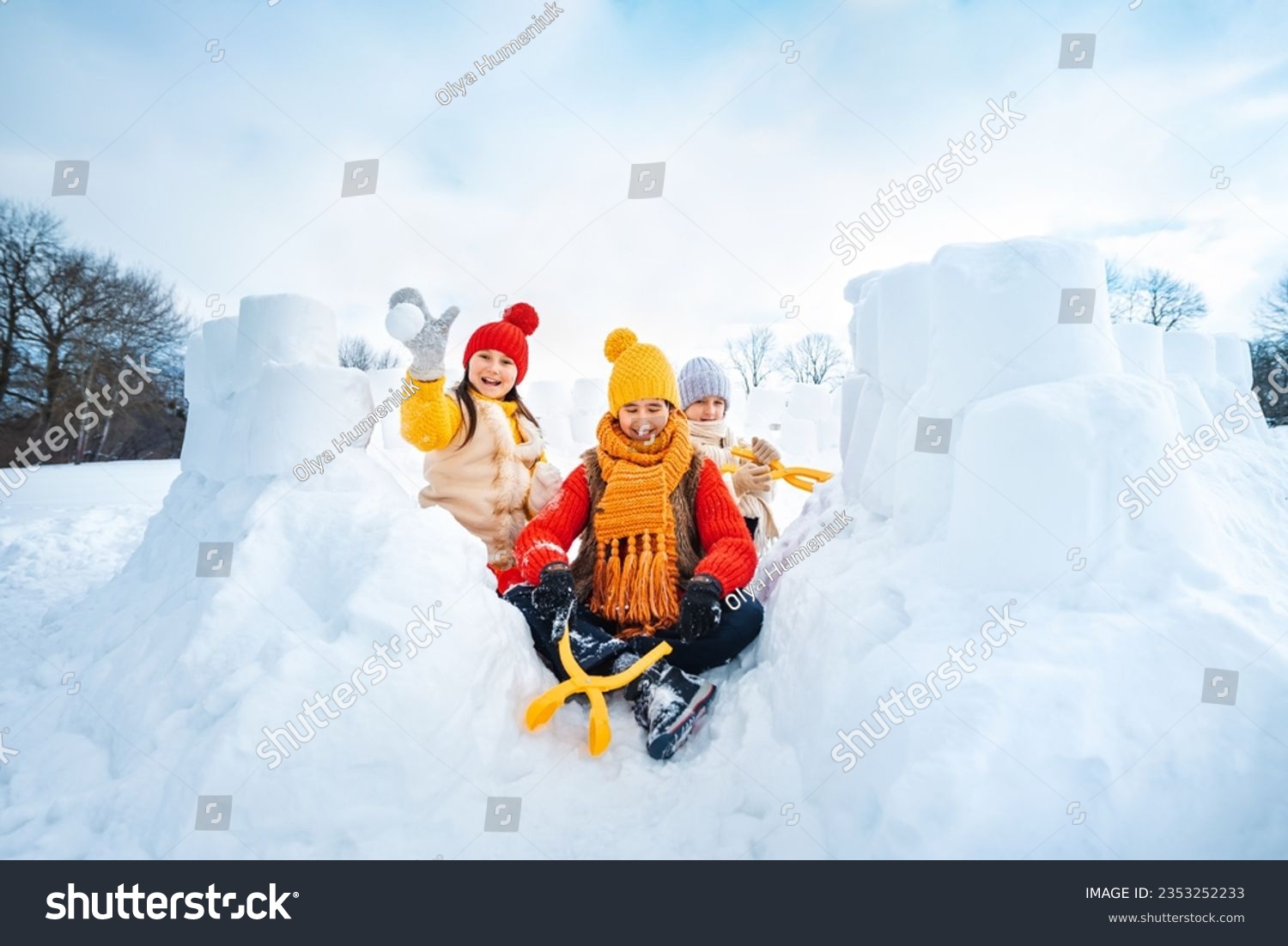 Group of children make snowballs for snowball fights. Children play in ...