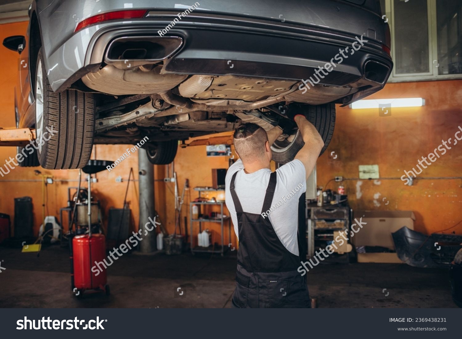 Handsome Professional Car Mechanic is Investigating Rust Under a ...