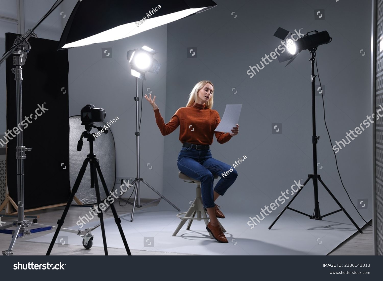 Casting call. Emotional woman with script sitting on chair and ...
