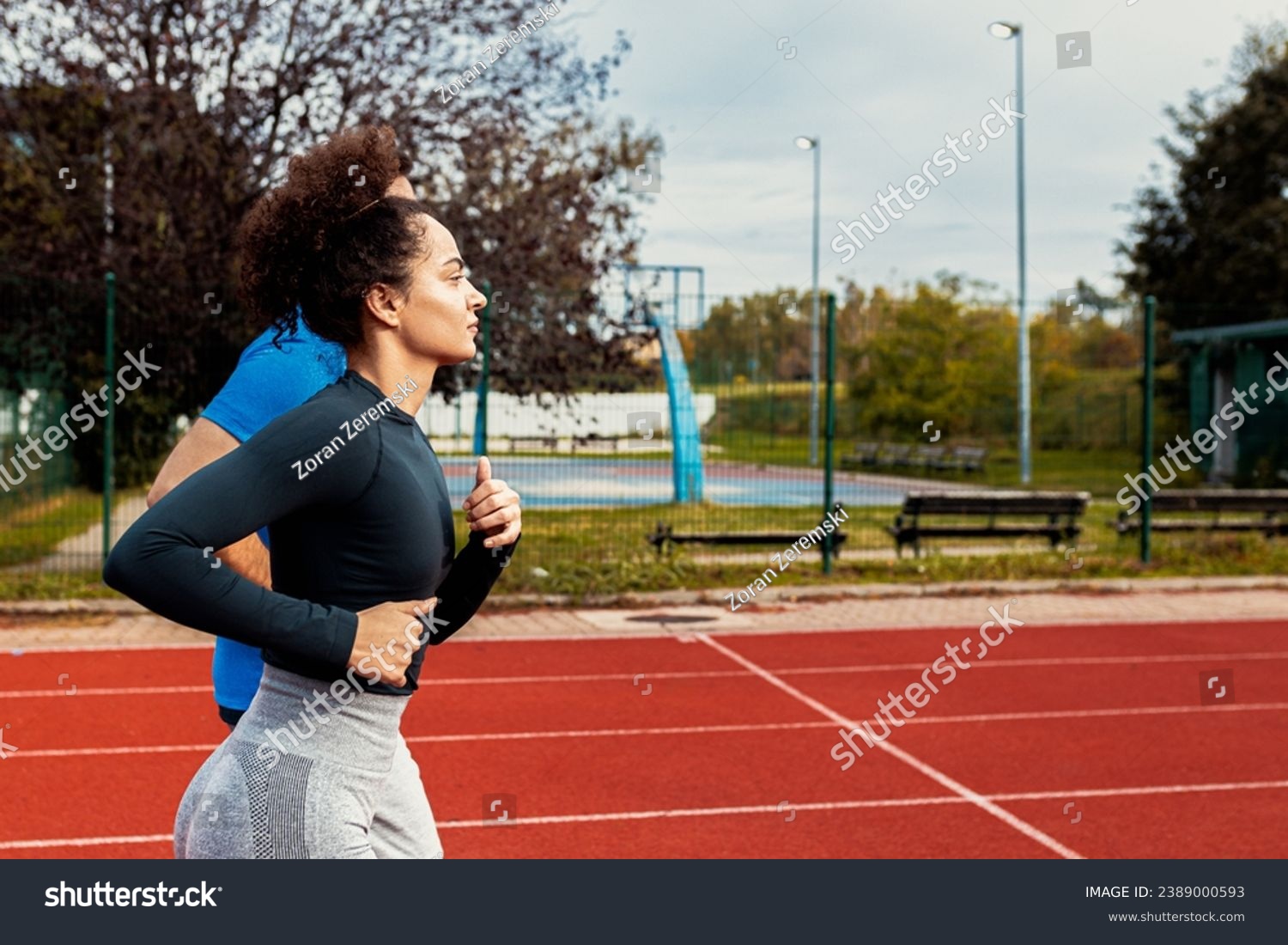 Woman and man doing morning workout outdoors running on track._站酷海洛_正版图片_视频_字体_音乐素材交易平台_站酷旗下品牌