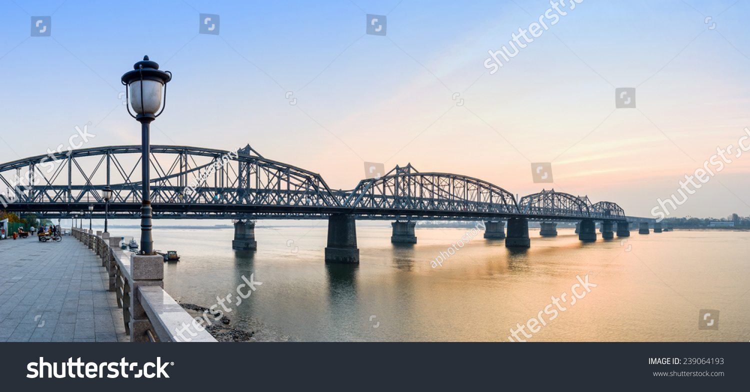 Yalu River Bridge at morning. In the distance is North Korea. Located ...