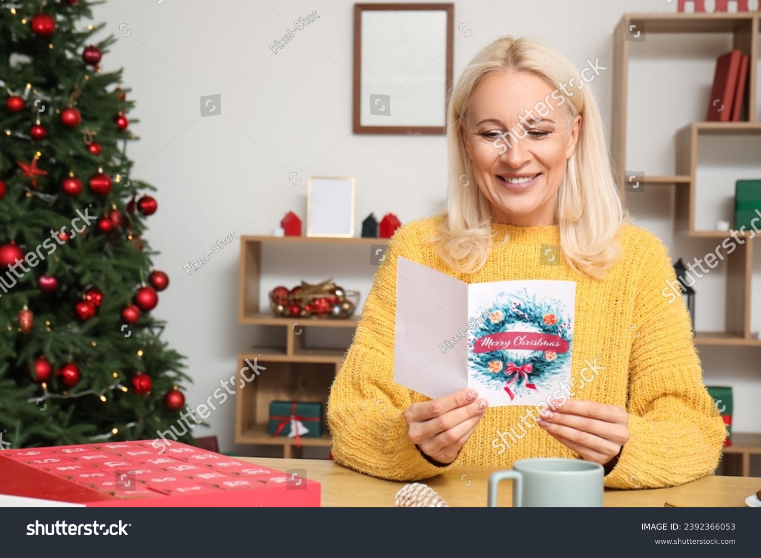 Mature woman reading greeting card for Christmas celebration at home_站酷 ...
