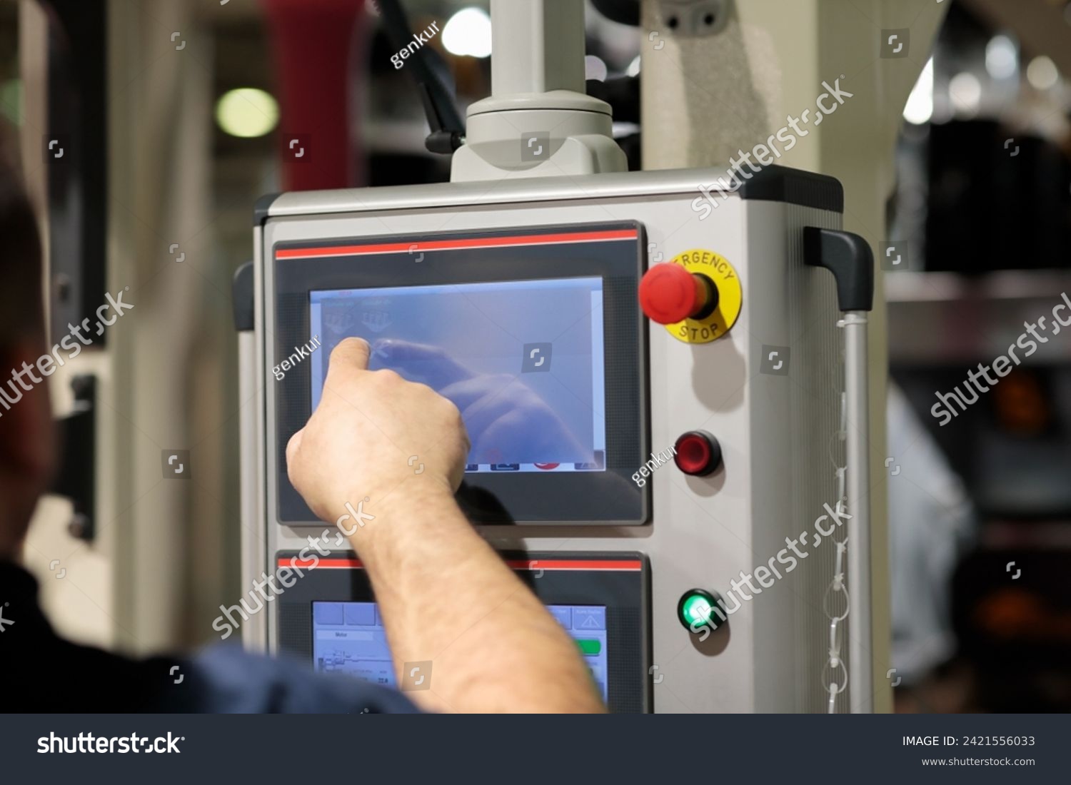 Operator working with touchscreen control panel of industrial machine ...