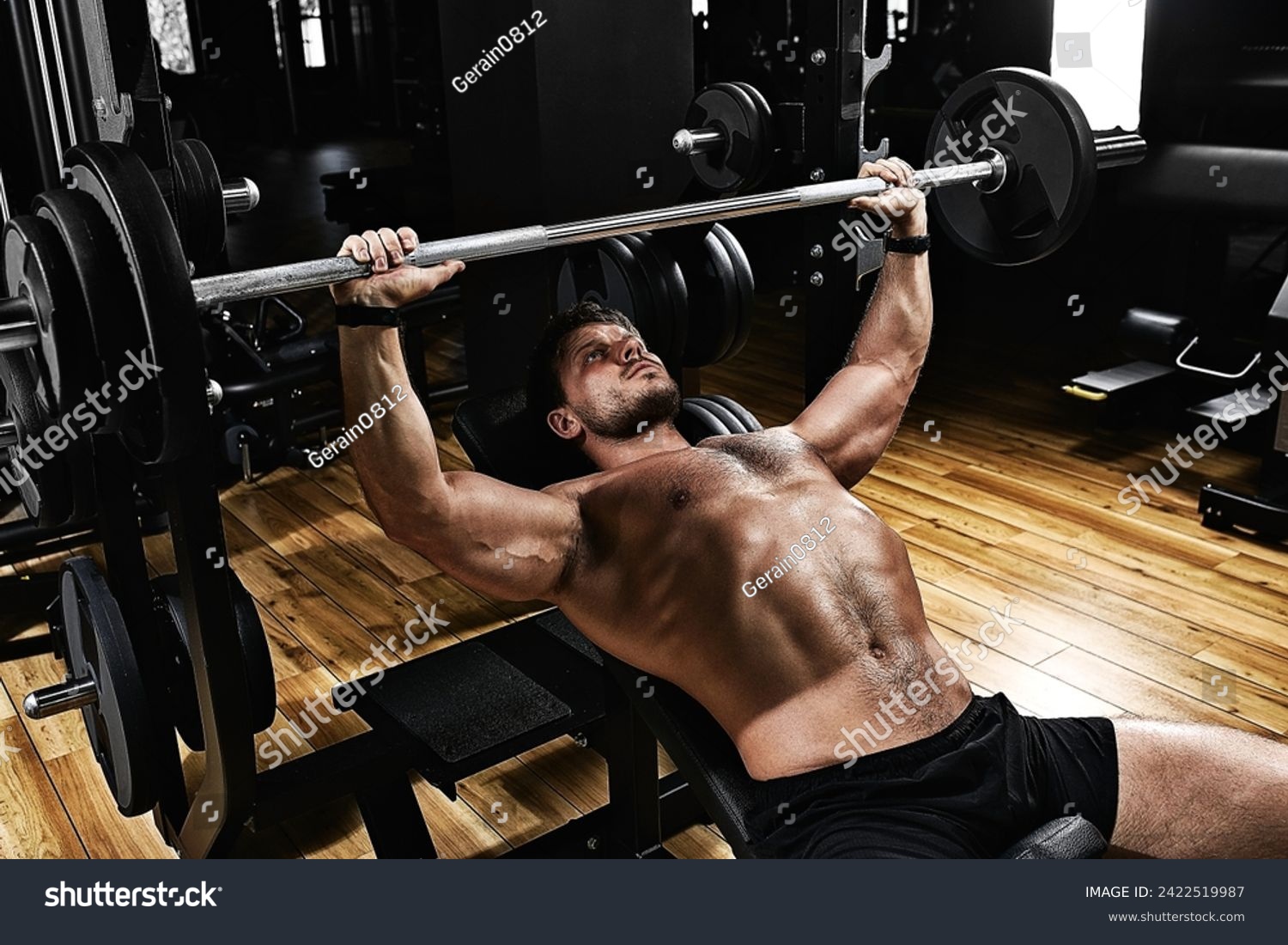 handsome young man doing bench press workout in gym Fitness motivation ...