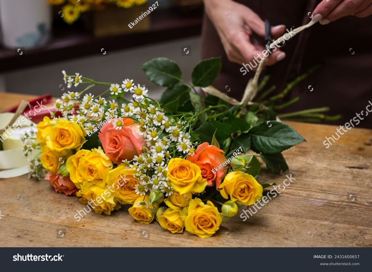 Bouquet of roses and daisies on the table the store close-up.Florist an ...