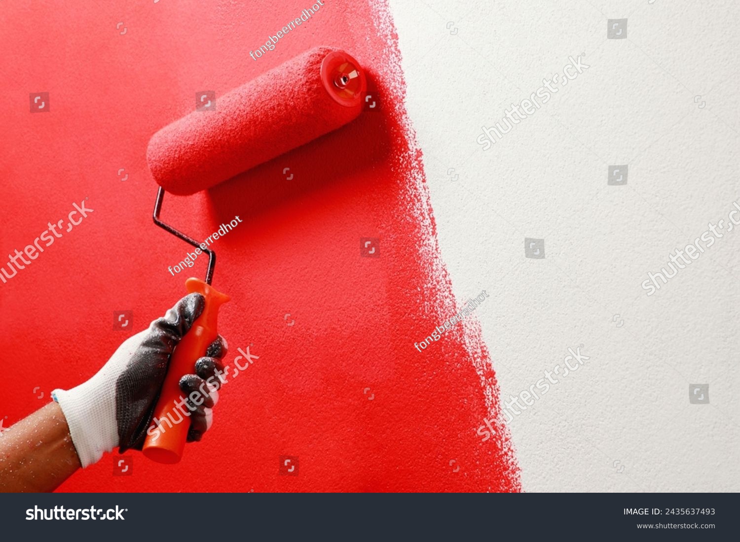 Roller Brush Painting Worker painting on surface wall Painting apartment renovating with red ...