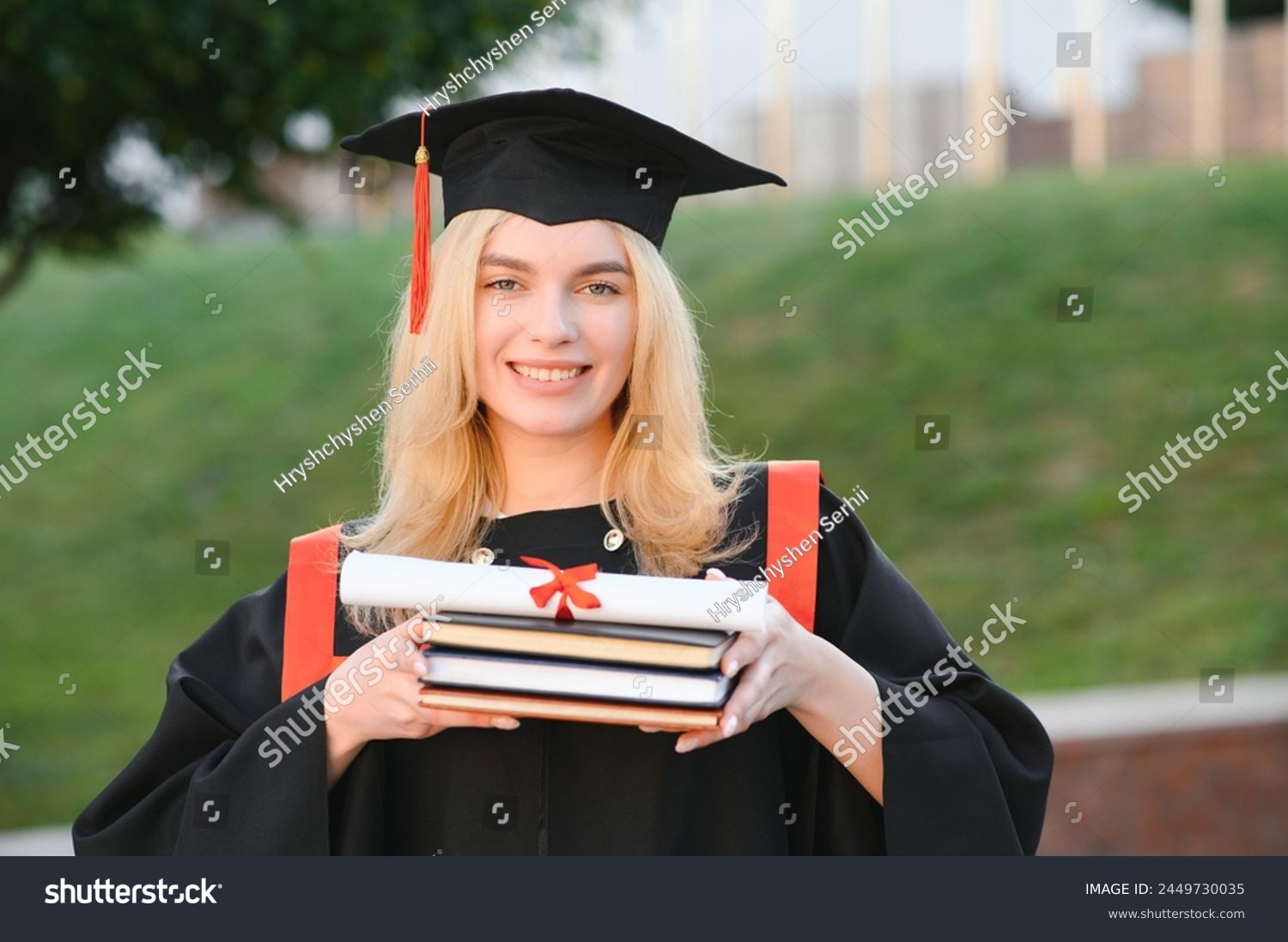 Portrait enthusiastic female college student graduate in cap and gown ...