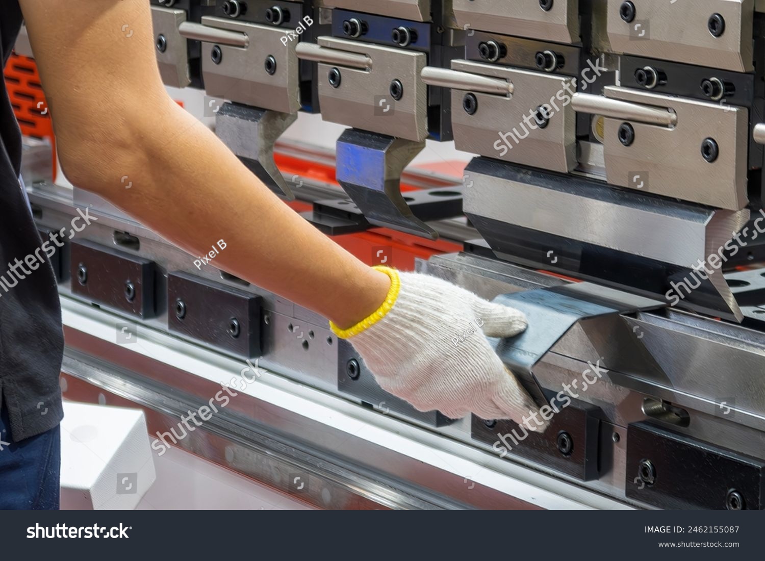 Close up the bending machine operator hold the sheet metal parts. The ...