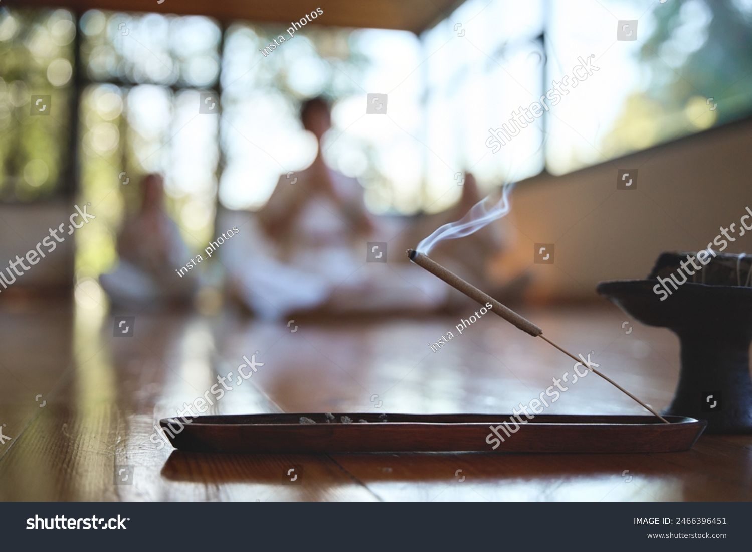 Scented stick on a wooden stand holder. Burning aromatic incense smoky ...