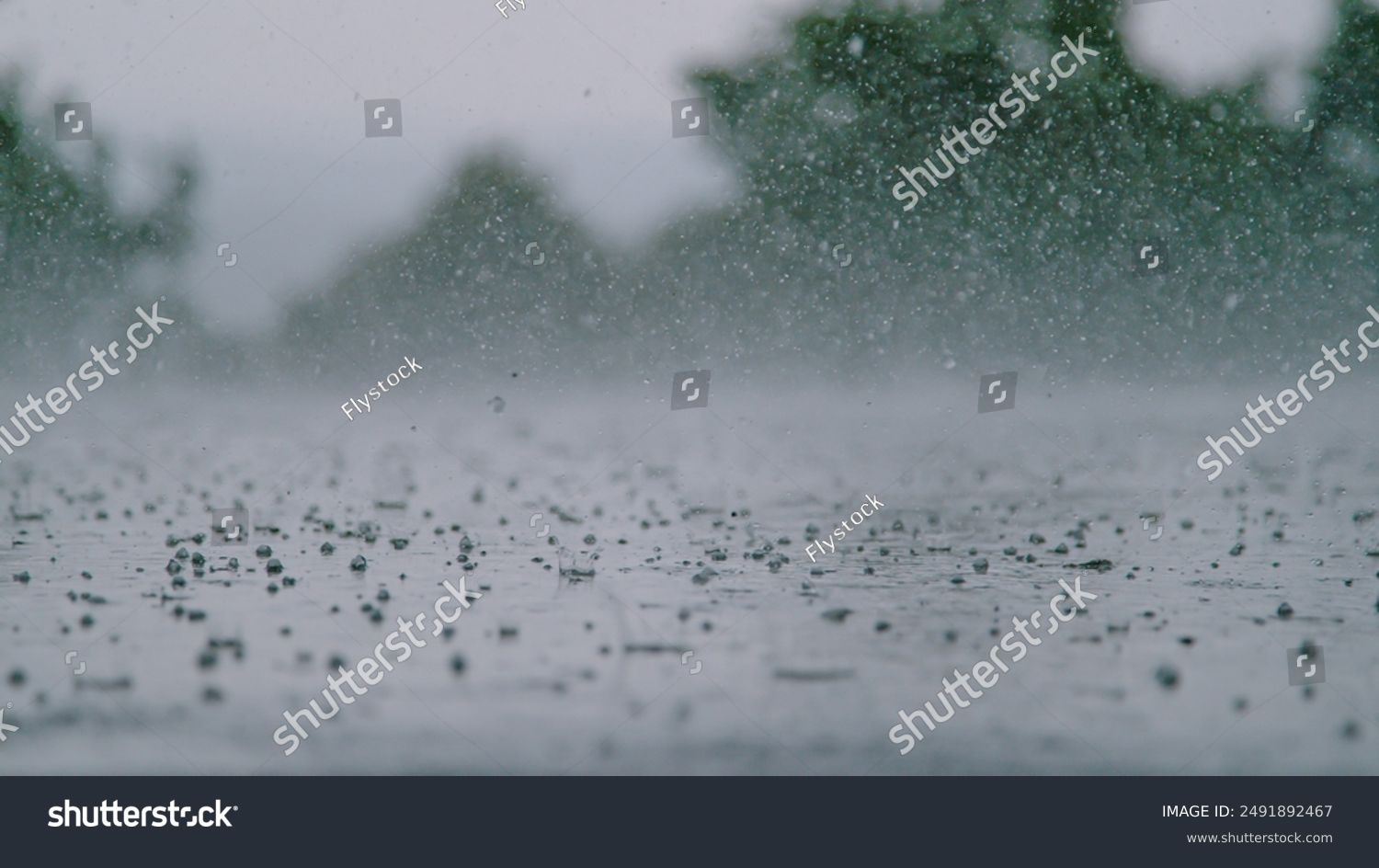 LOW ANGLE CLOSE UP DOF: Cinematic shot of hail falling on the asphalt ...