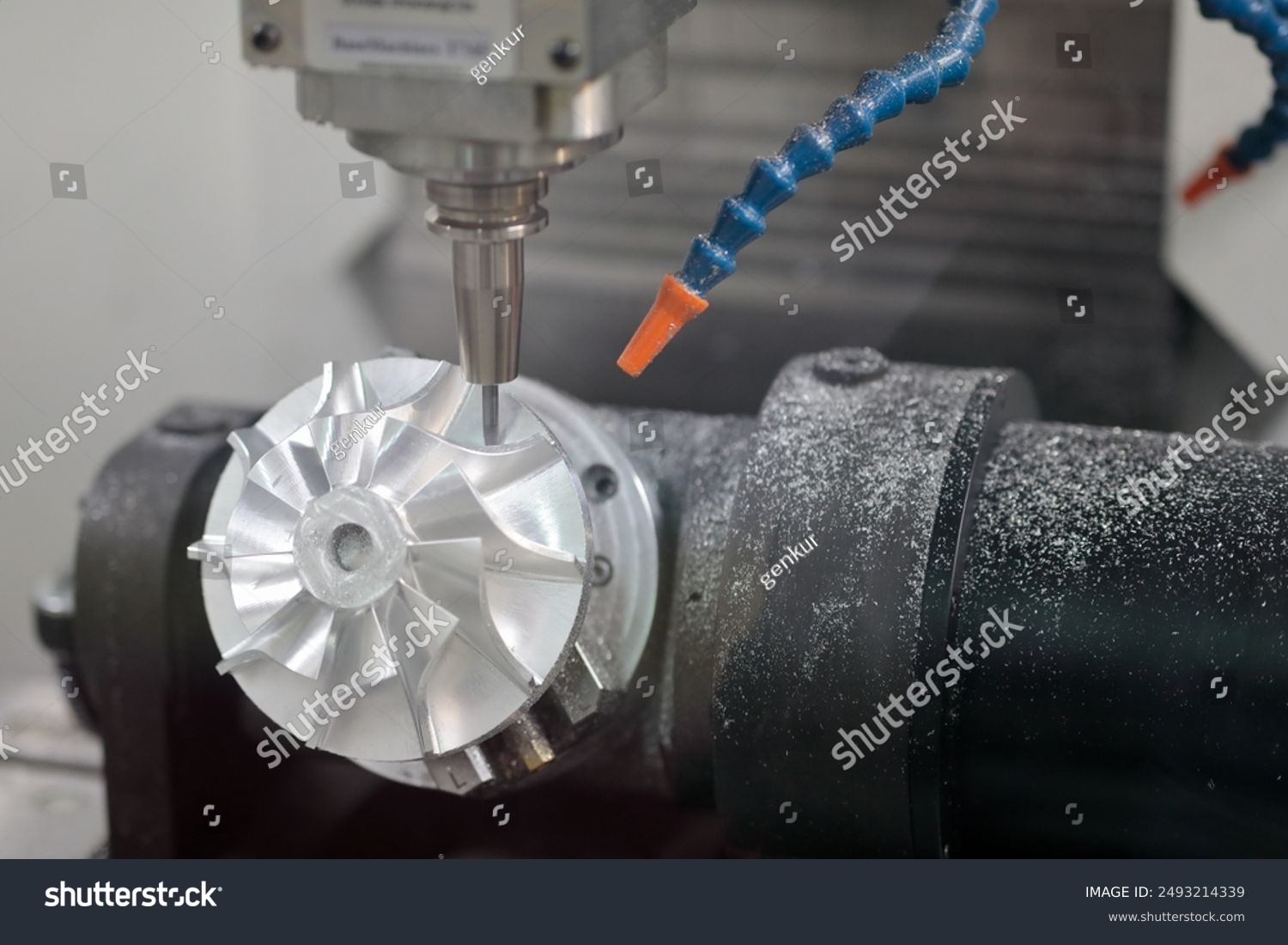 Automatic milling of turbine wheel with industrial 5 axis CNC machining center. Selective focus ...