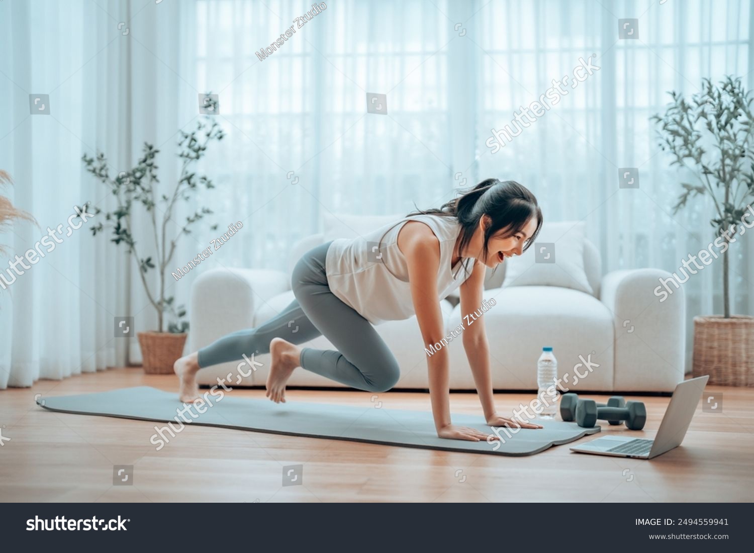 Young Asian woman doing sport exercises indoor. Beautiful girl workout ...