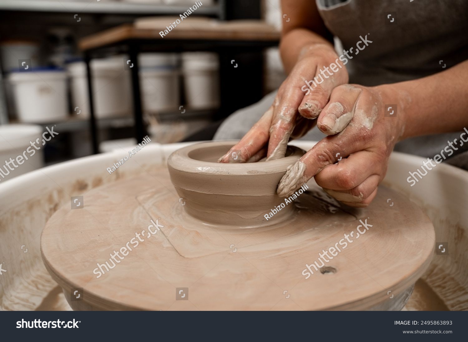 Creating a ceramic bowl by yourself in a pottery class. Wheel throwing ...