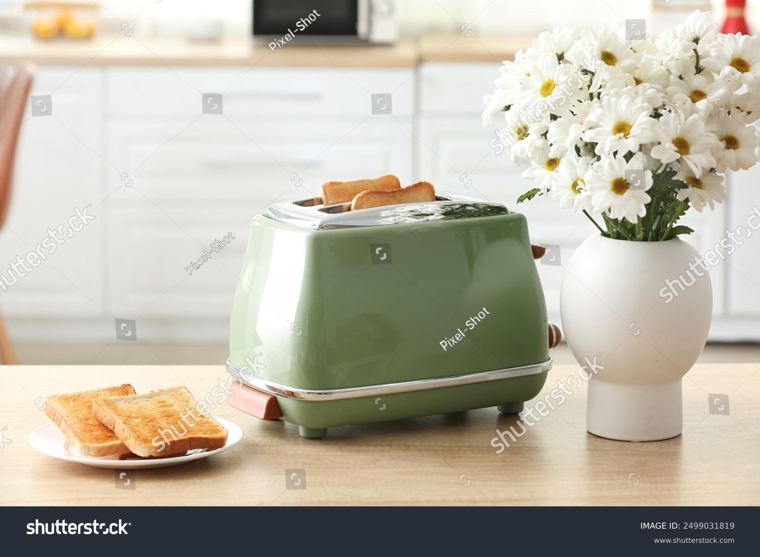 Modern toaster with crispy bread slices and flower vase on table in kitchen_站酷海洛_正版图片_视频_字体_音乐素材 ...